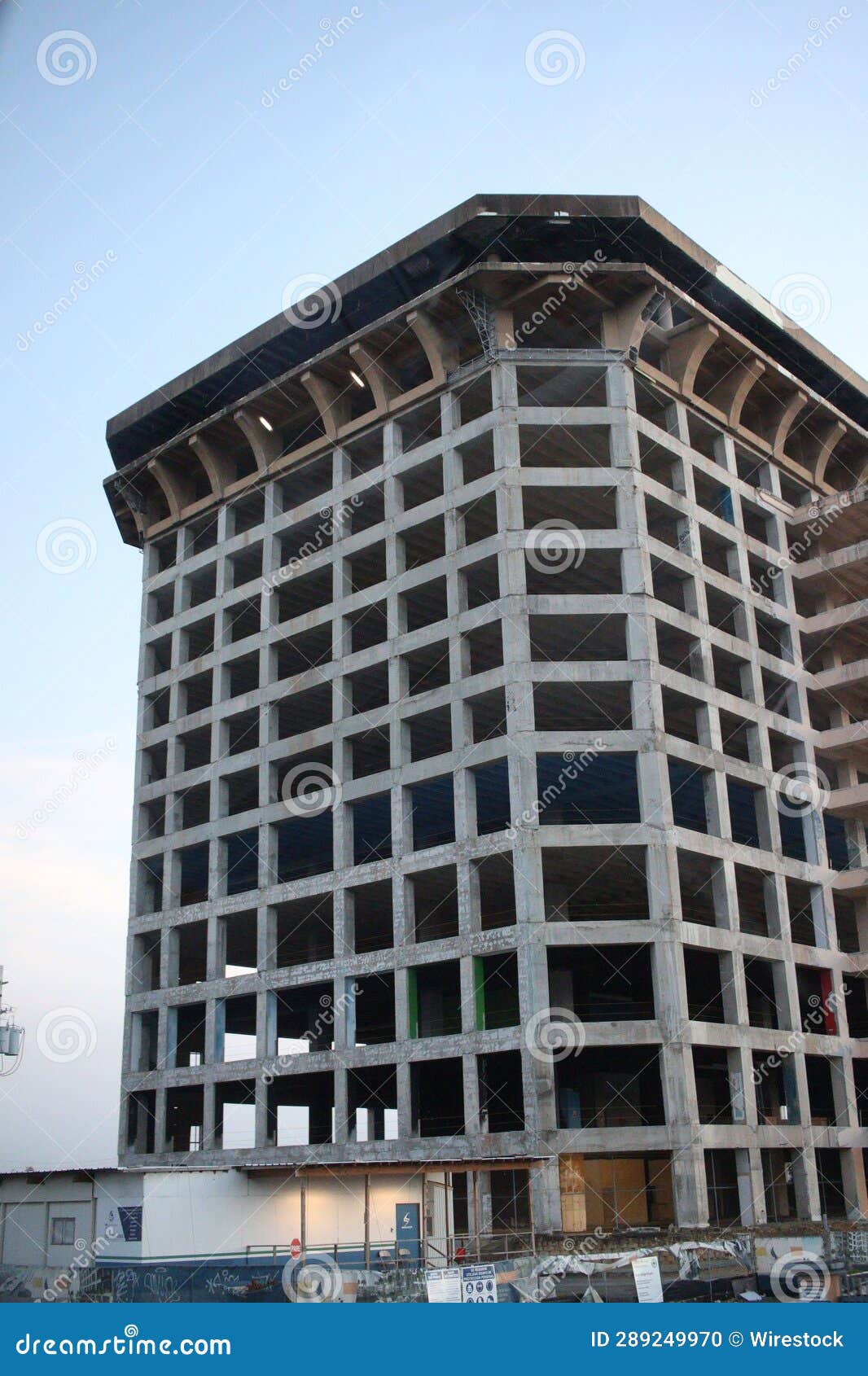 A Large Building that Has a Construction Site Next To it Stock Photo ...