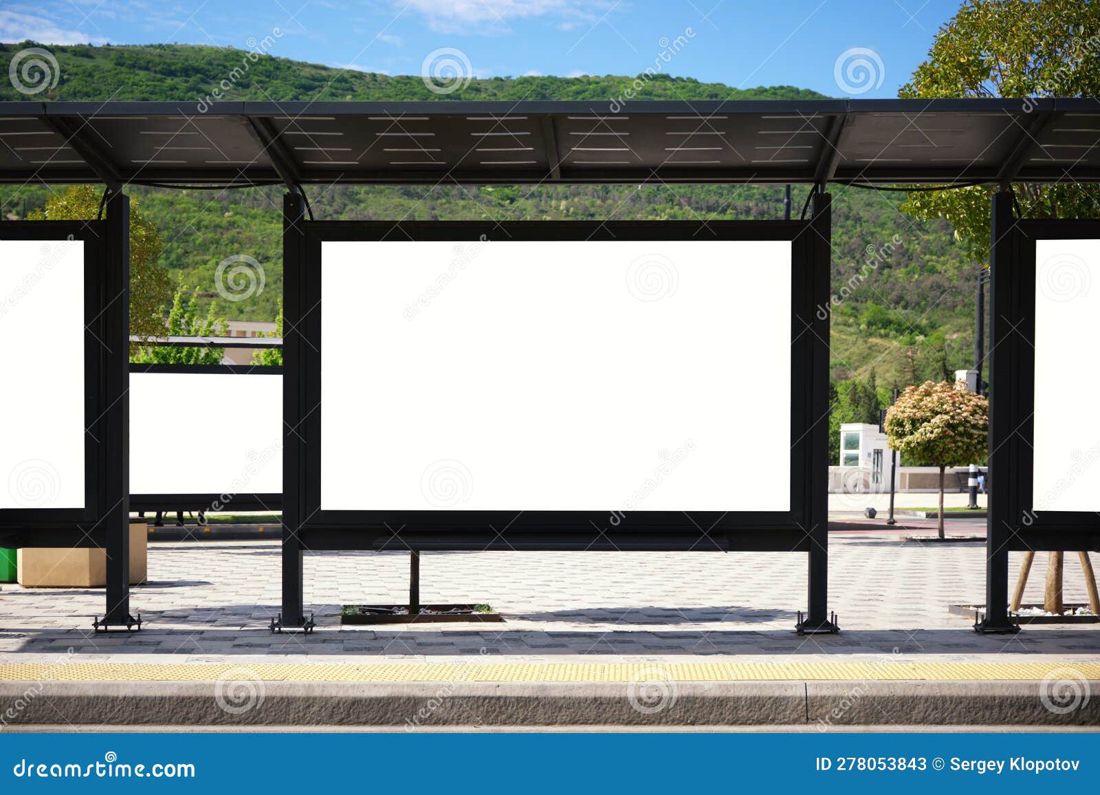 A Large Bus Stop Against the Backdrop of the Mountains with Empty ...