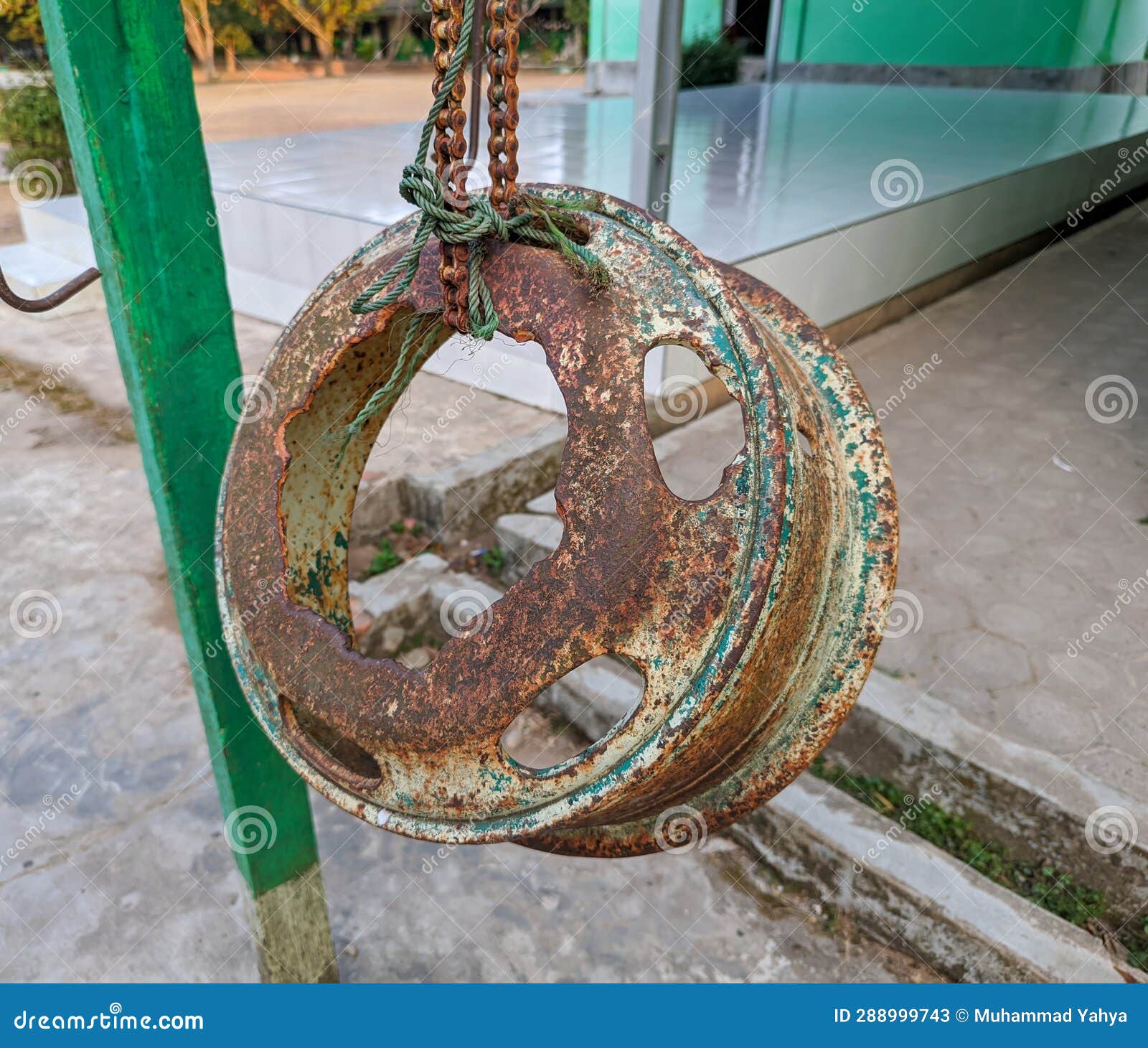 A Large Car Tire Rim that Has Been Converted into a School Bell Stock ...