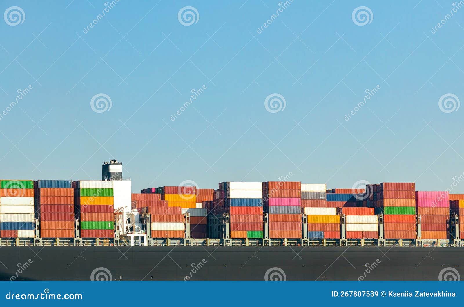 Large Cargo Container Ship Loaded with Containers Against the Blue Sky ...