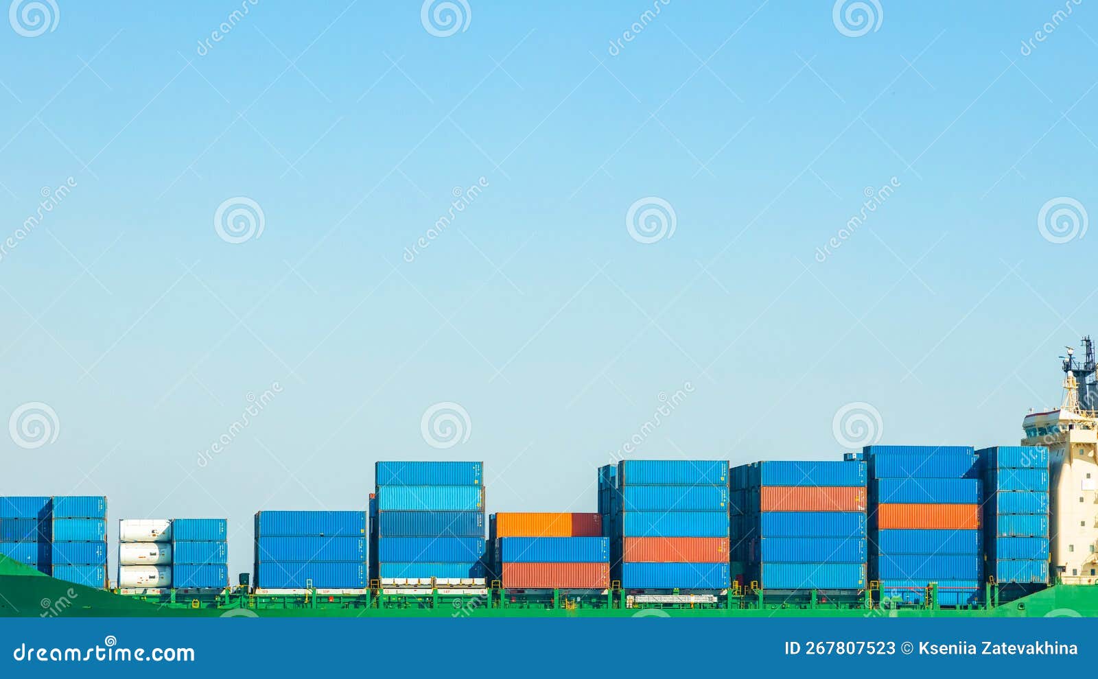 A Large Cargo Container Ship Loaded with Containers Against the Blue ...