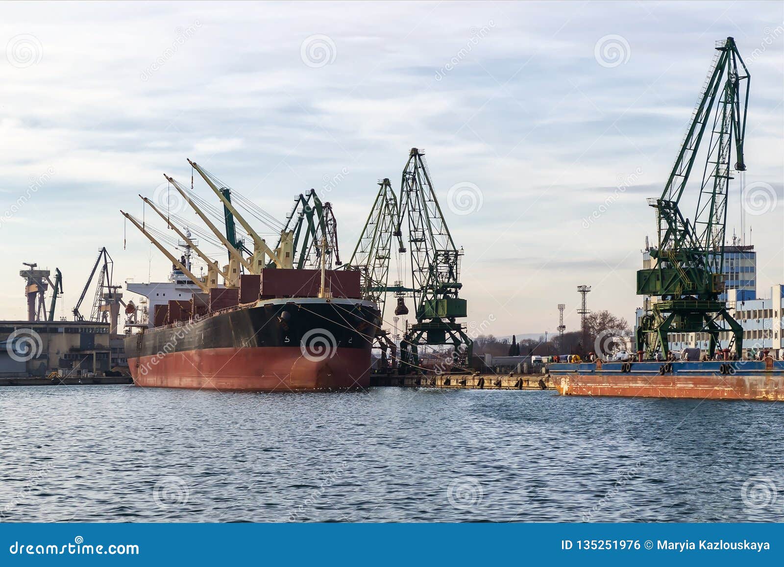 Large Cargo Ship in the Seaport during Loading. Cranes Load the Cargo ...
