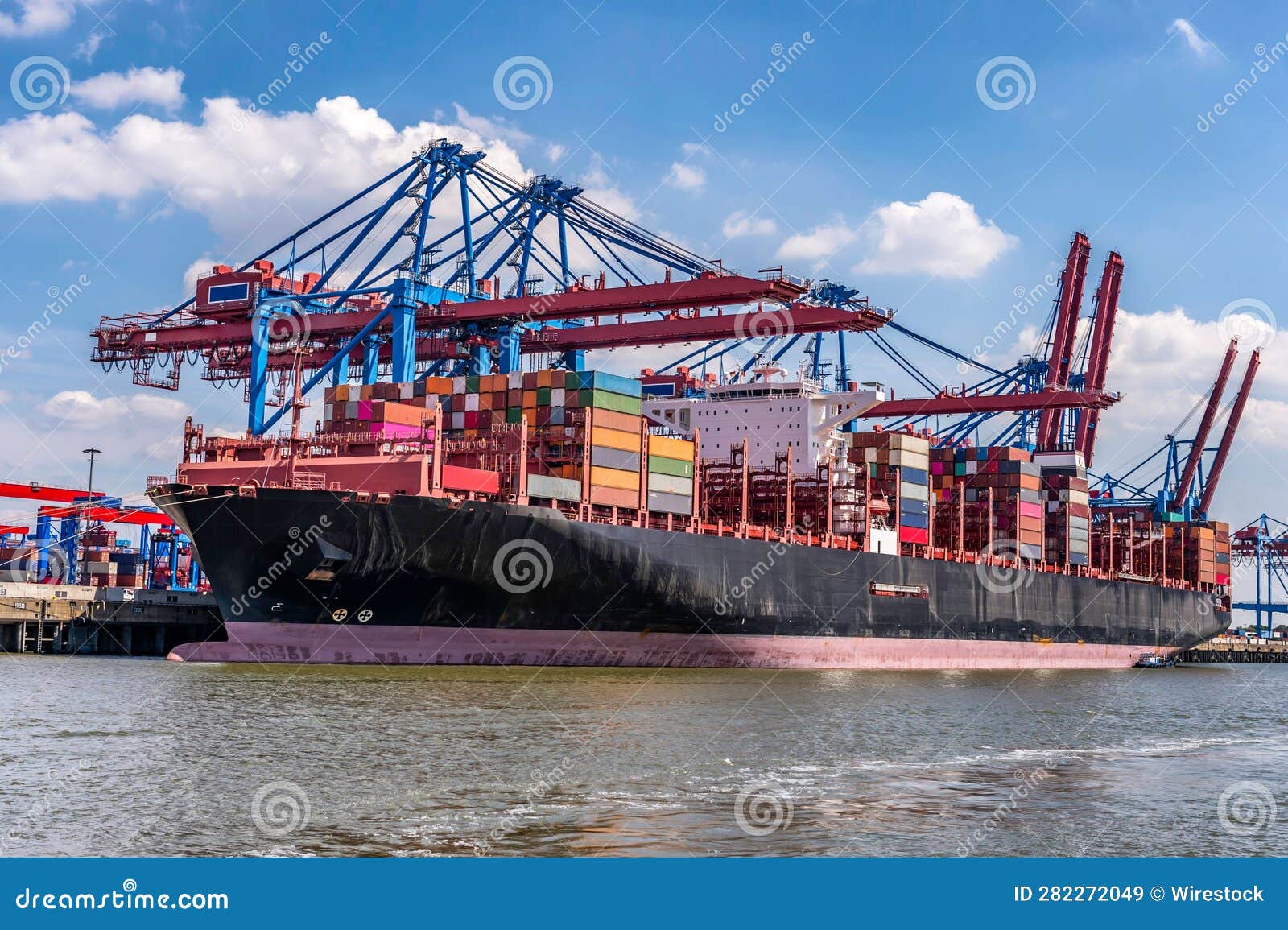 Large Cargo Vessel Docked at a Port, with Several Gantry Cranes Visible ...