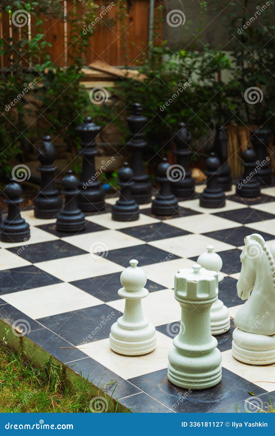 A Large Chess Board Featuring Oversized Giant Chess Pieces Placed on it ...
