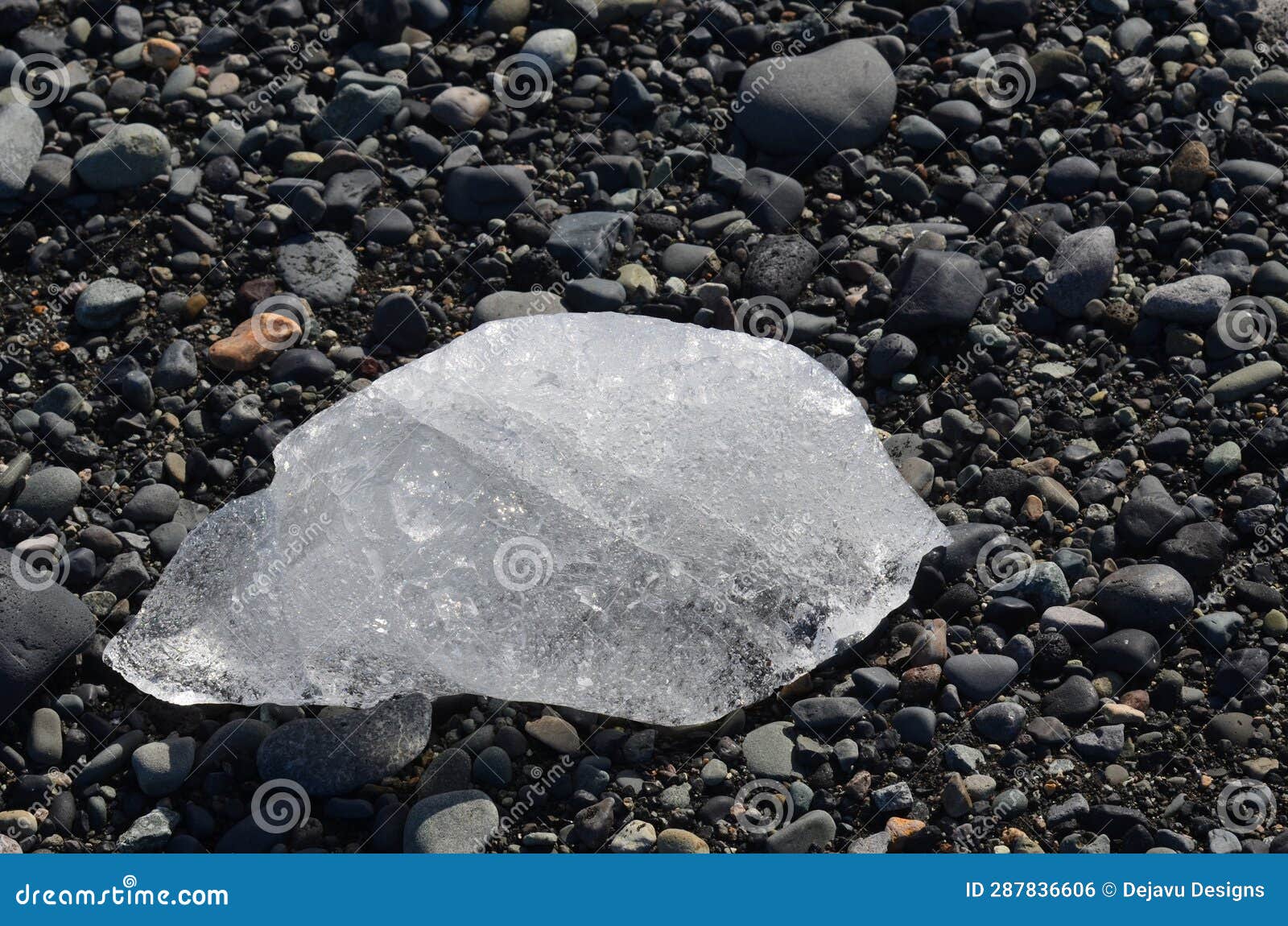 Large Chunk of Ice on a Black Stone Beach Stock Photo - Image of ...