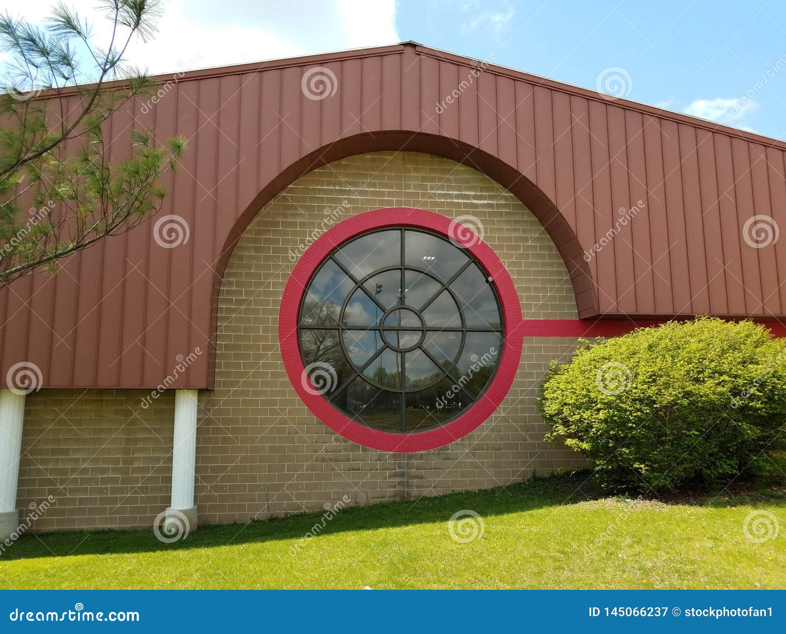 Large Circular Glass Window with Wasp Nest on Brick Building Stock ...