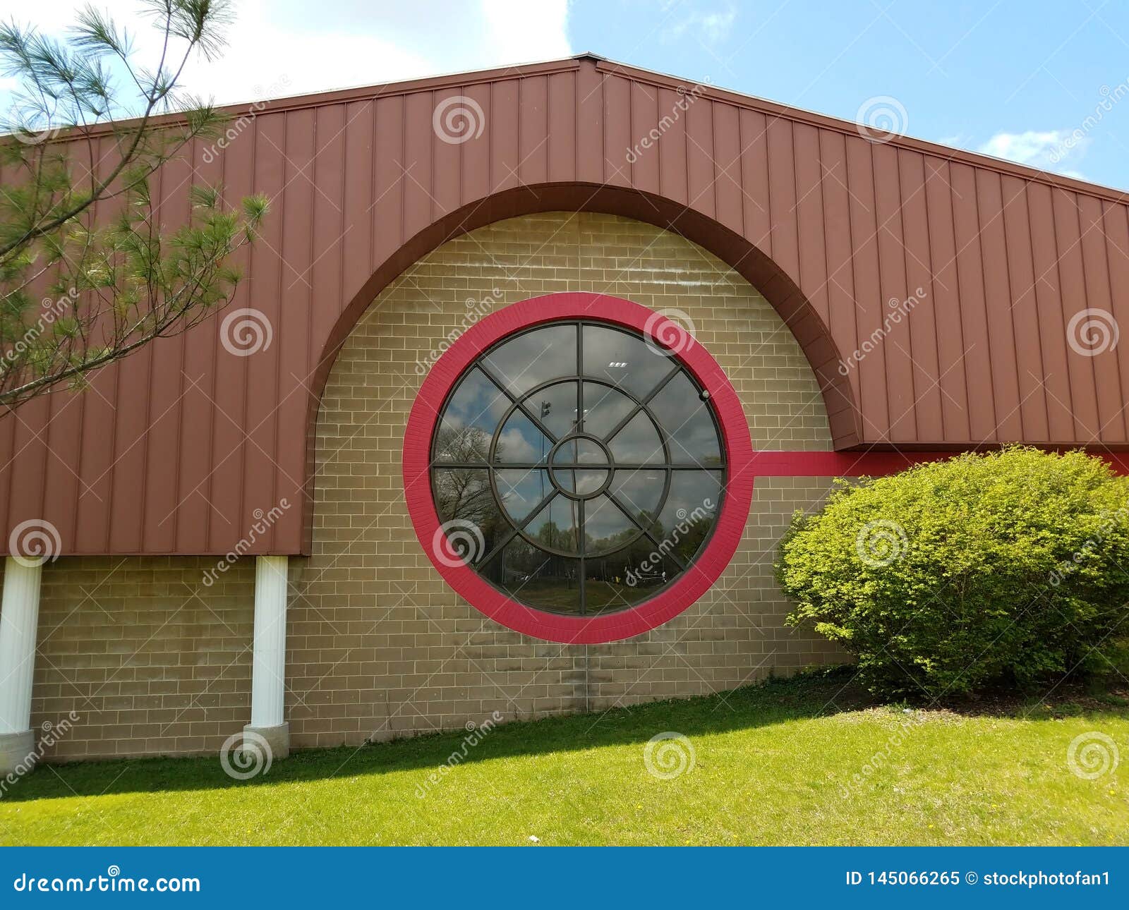 Large Circular Glass Window with Wasp Nest on Brick Building Stock ...