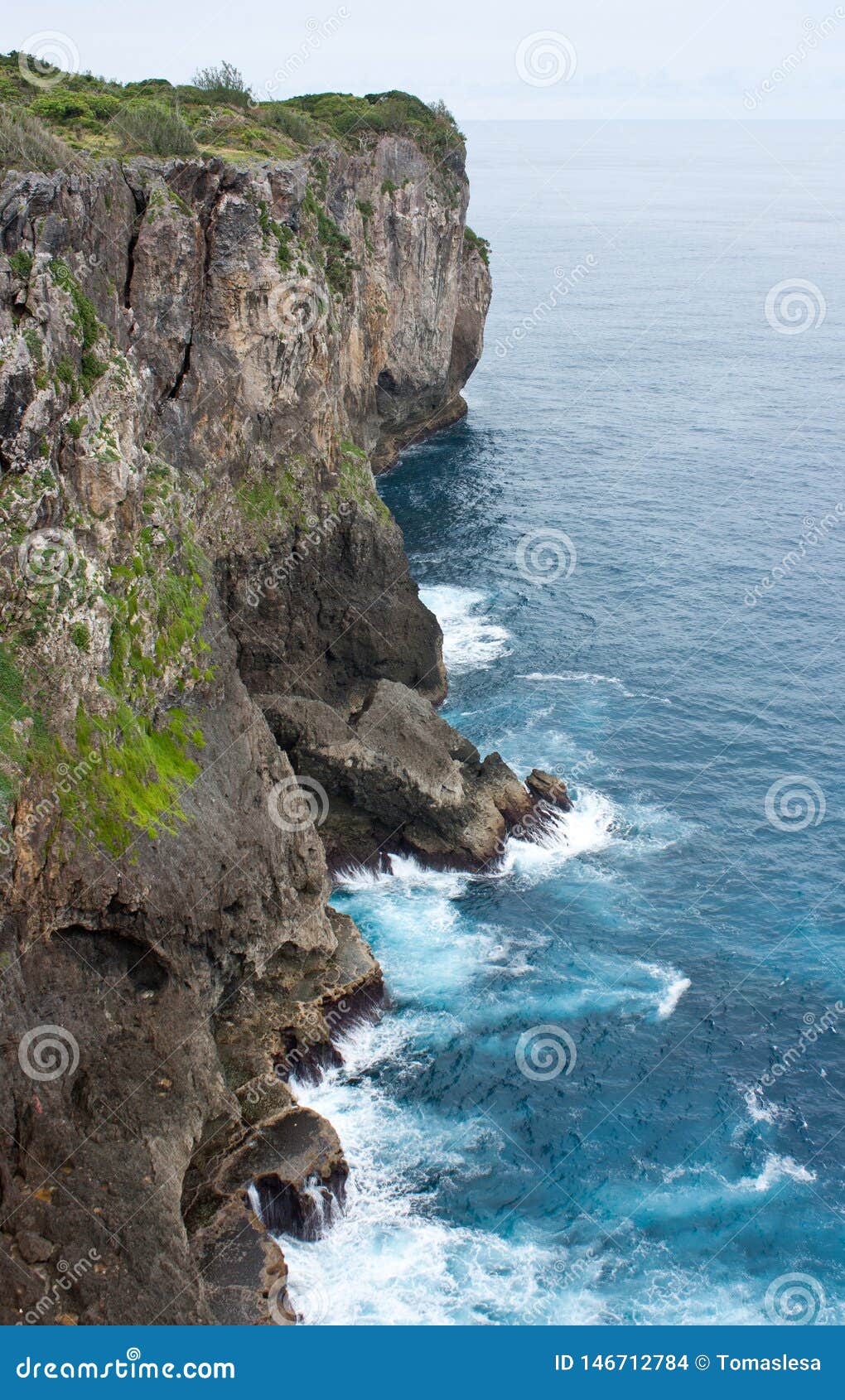 A Large Cliff with Waves Crashng Against it in Tonga Stock Photo ...