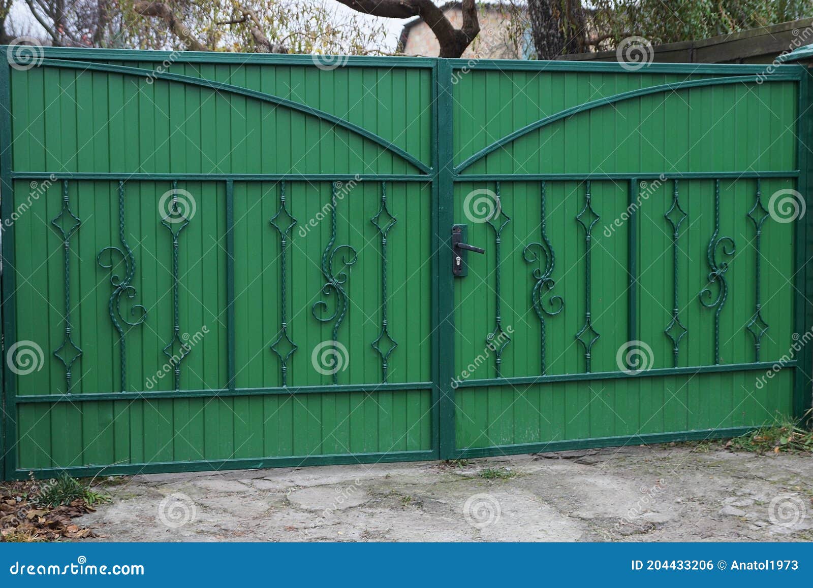 Large Closed Green Metal Gate with Wrought Iron Pattern Stock Photo ...