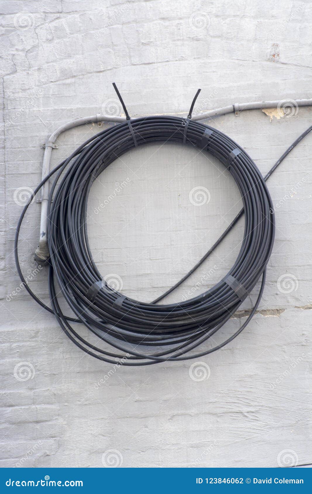 Cable coil on wall stock photo. Image of conduit, wire - 123846062