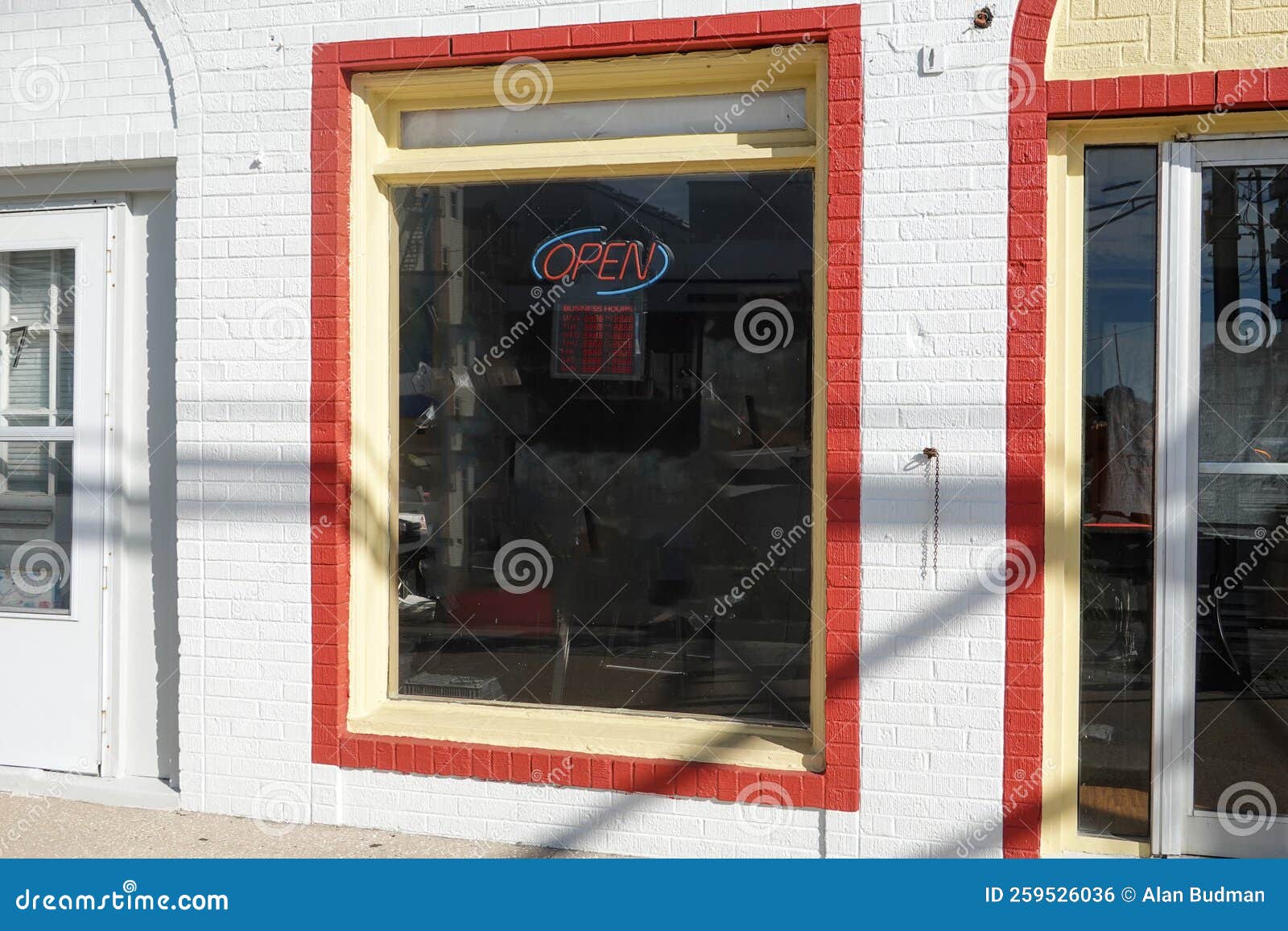 Large Colorful Store Front Window with a Neon Open Sign and a Red ...