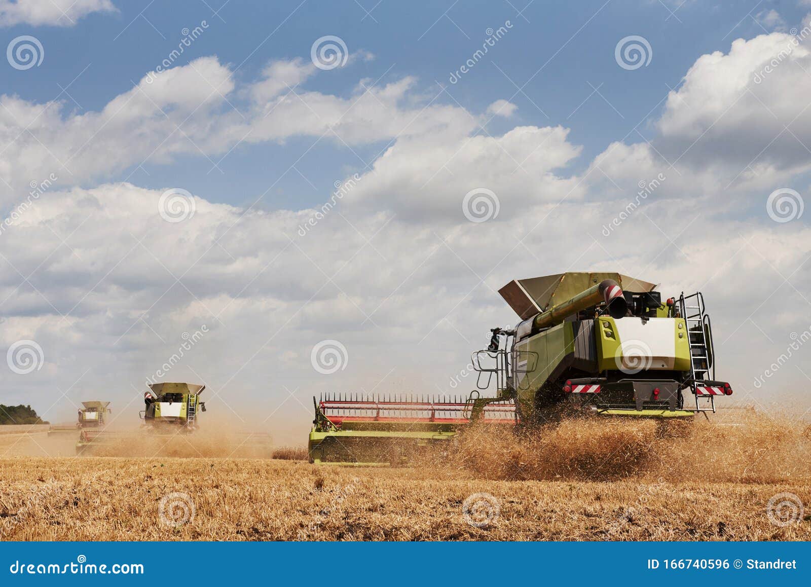 Large Combine Harvesters Working in Agriculturic Field at Summertime ... Large Combine Harvesters Working in Agriculturic Field at Summertime ...
