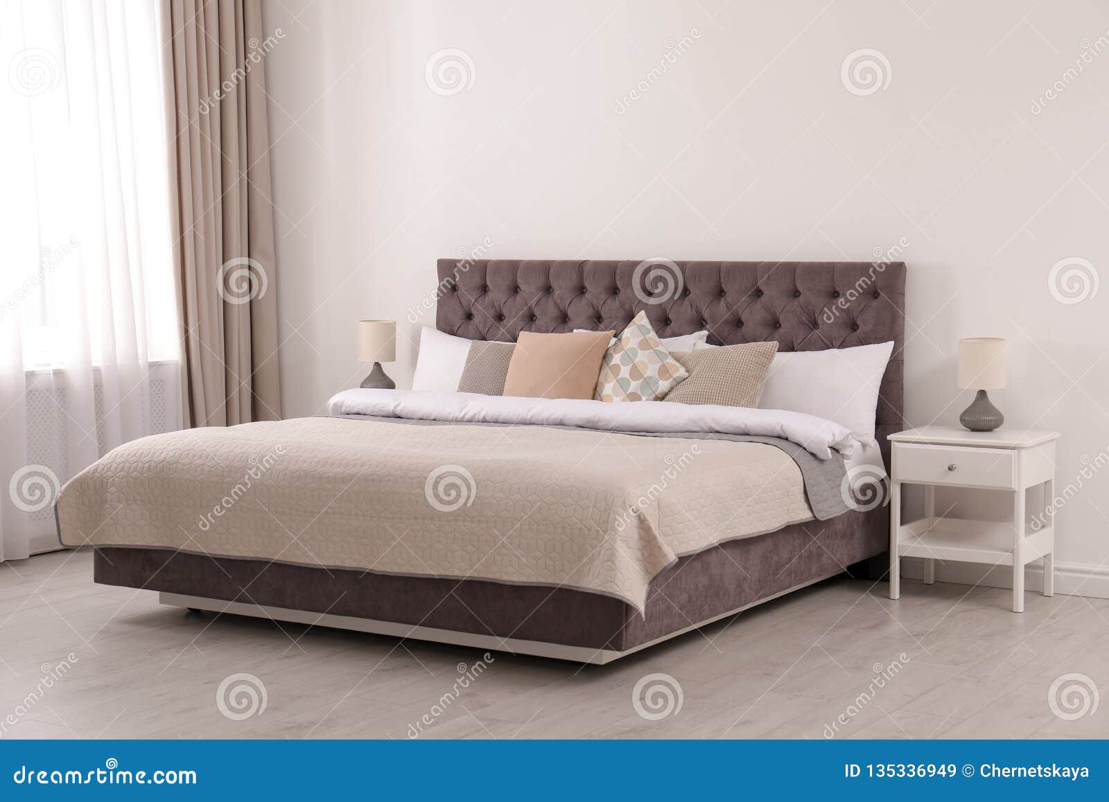 Large Comfortable Bed Near Light Wall in Simple Room Stock Image ...