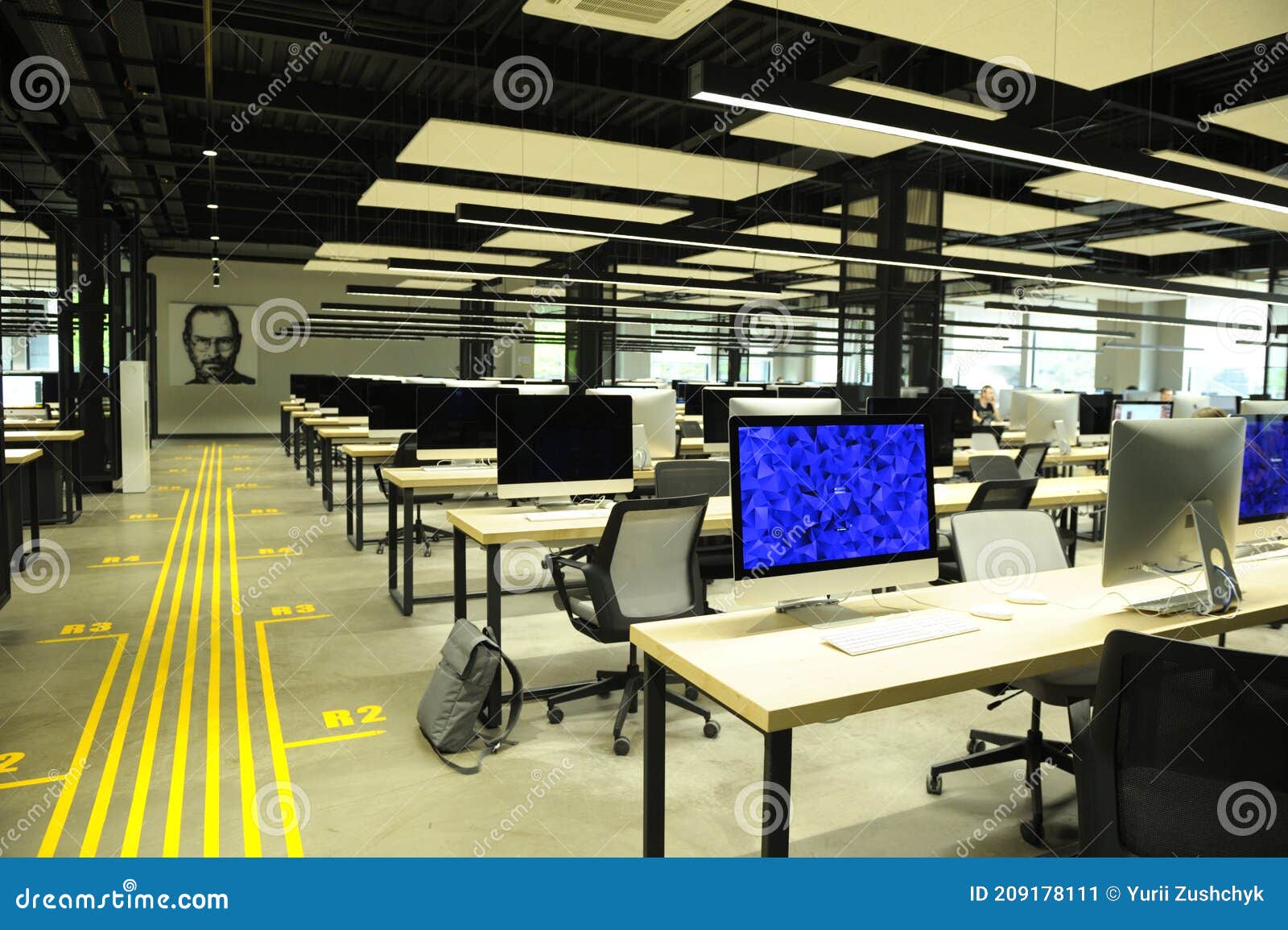 Large Computer Room with Laptops on Tables, Blurred People Working ...