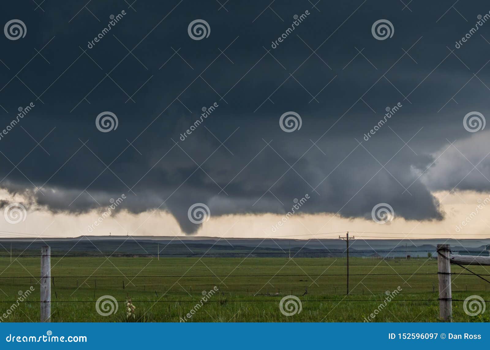 A Large Cone Tornado Under the Base of a Dark Storm on the Plains ...