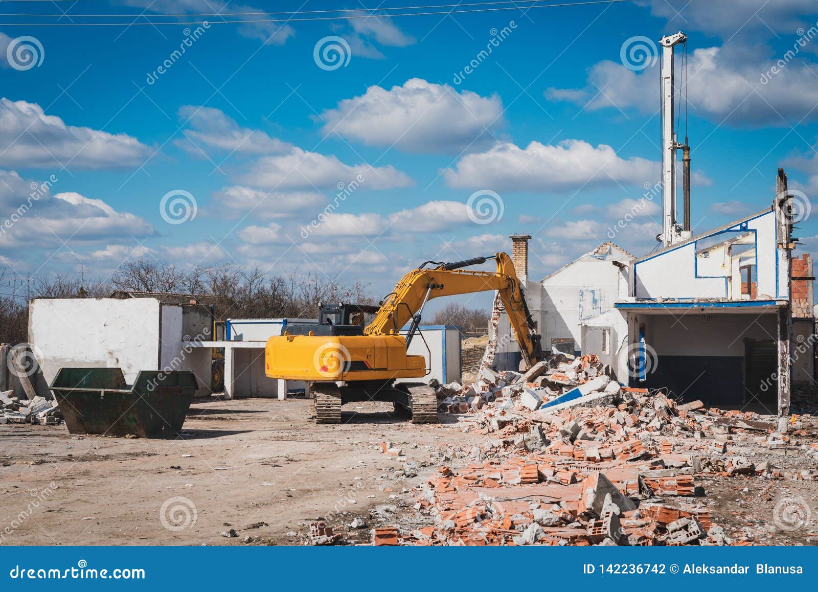 Large Construction Machines are Knocking Down the Houses on the ...