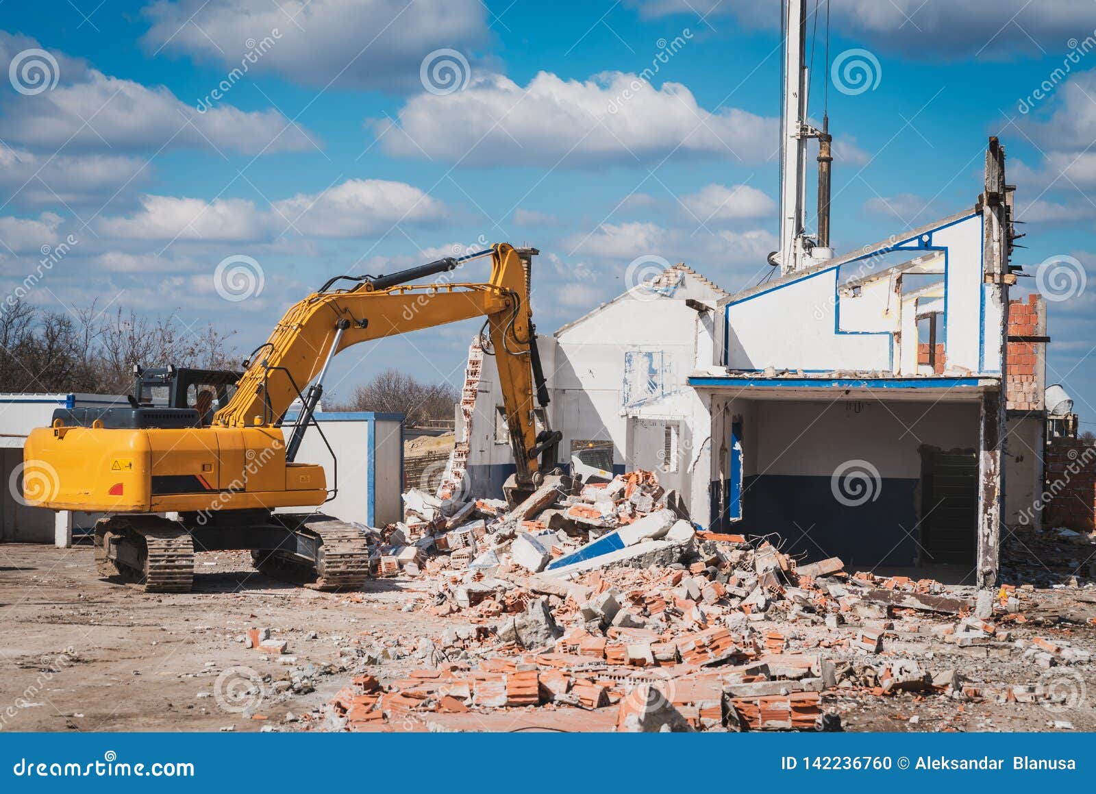 Large Construction Machines are Knocking Down the Houses on the ...