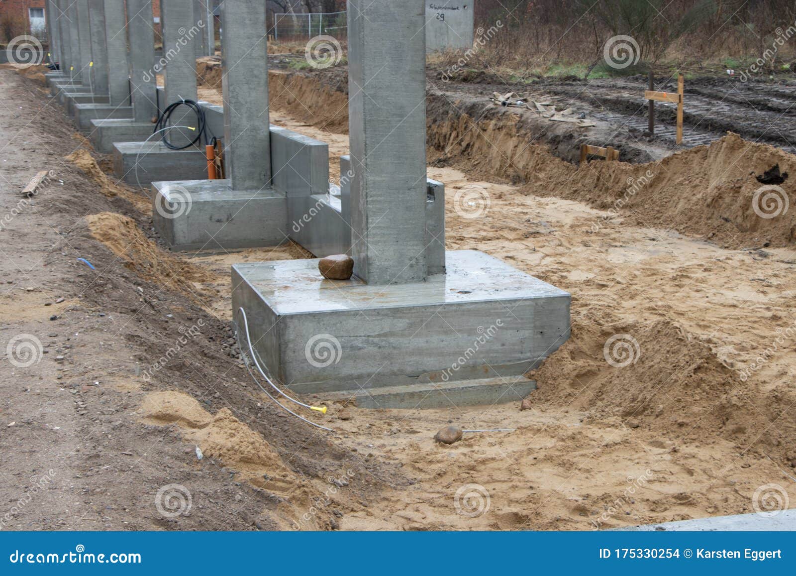 A Large Construction Site Many Concrete Columns are Placed with the ...