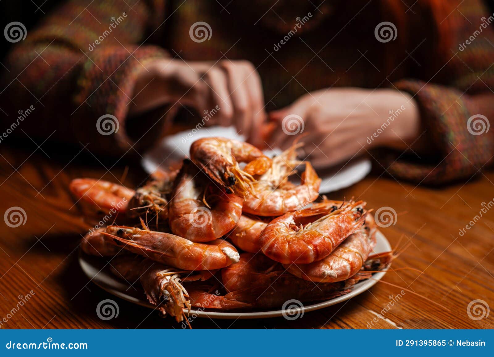 Large Cooked King Prawns on the Table. an Unrecognizable Man is Eating ...