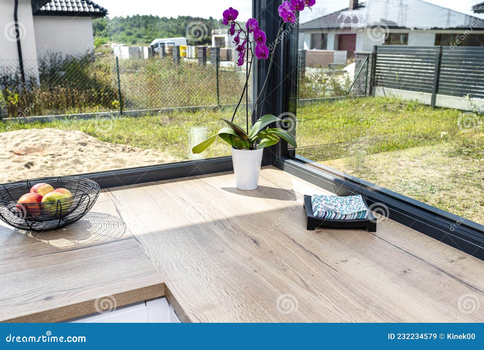 Large Corner Window in a Modern Kitchen with Built-in Cabinets Against ...