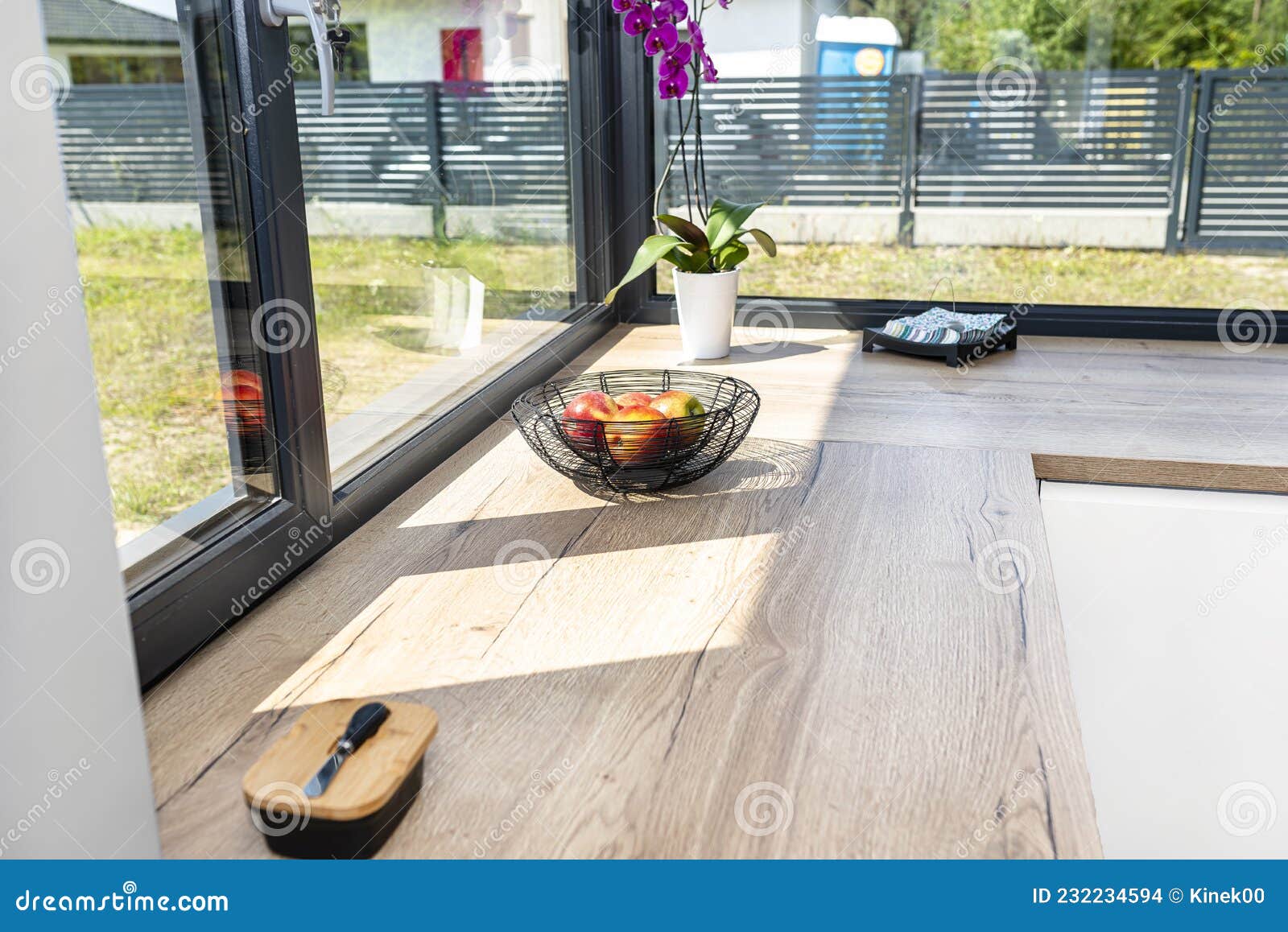 Large Corner Window in a Modern Kitchen with Built-in Cabinets Against ...