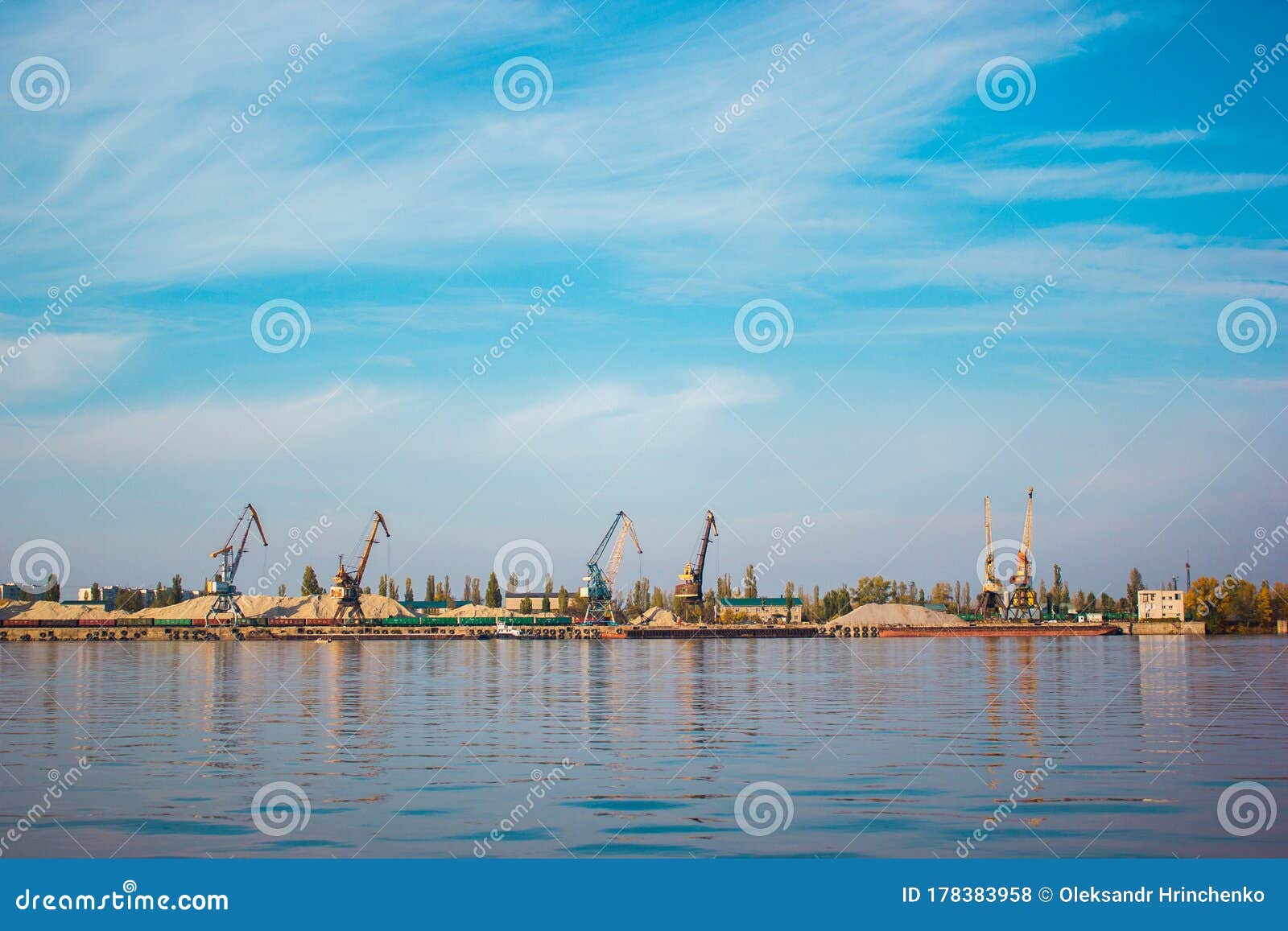 Large cranes by the river stock photo. Image of boat - 178383958