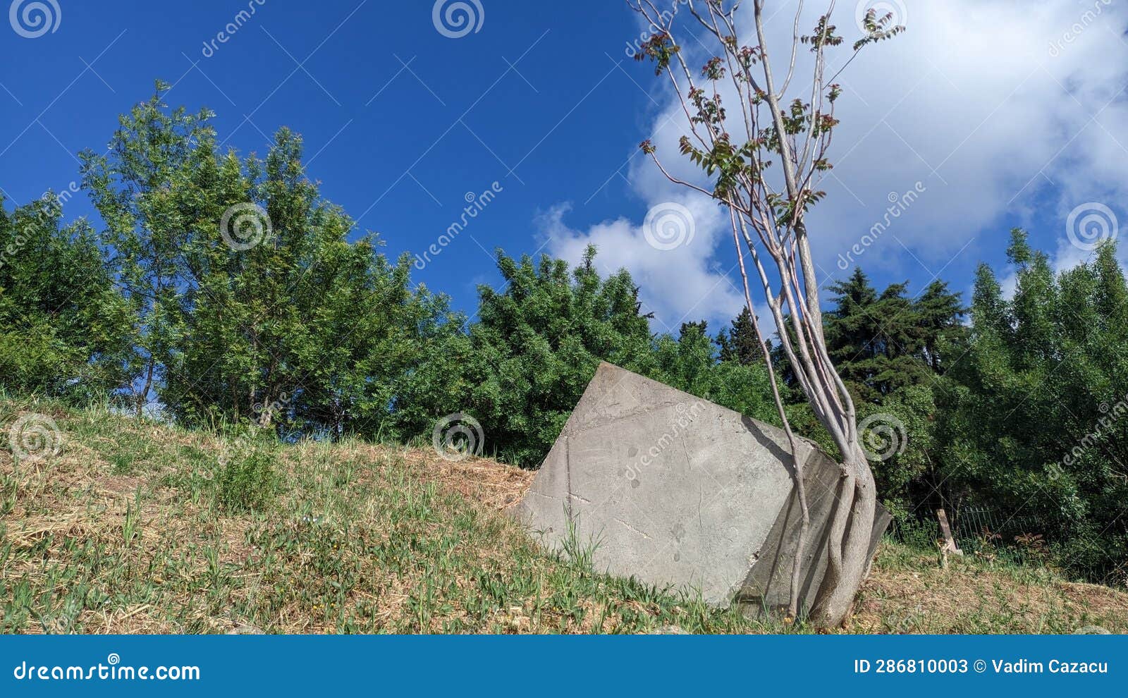 A Large Cube of Concrete Slid Down the Ground and Rested Against the ...