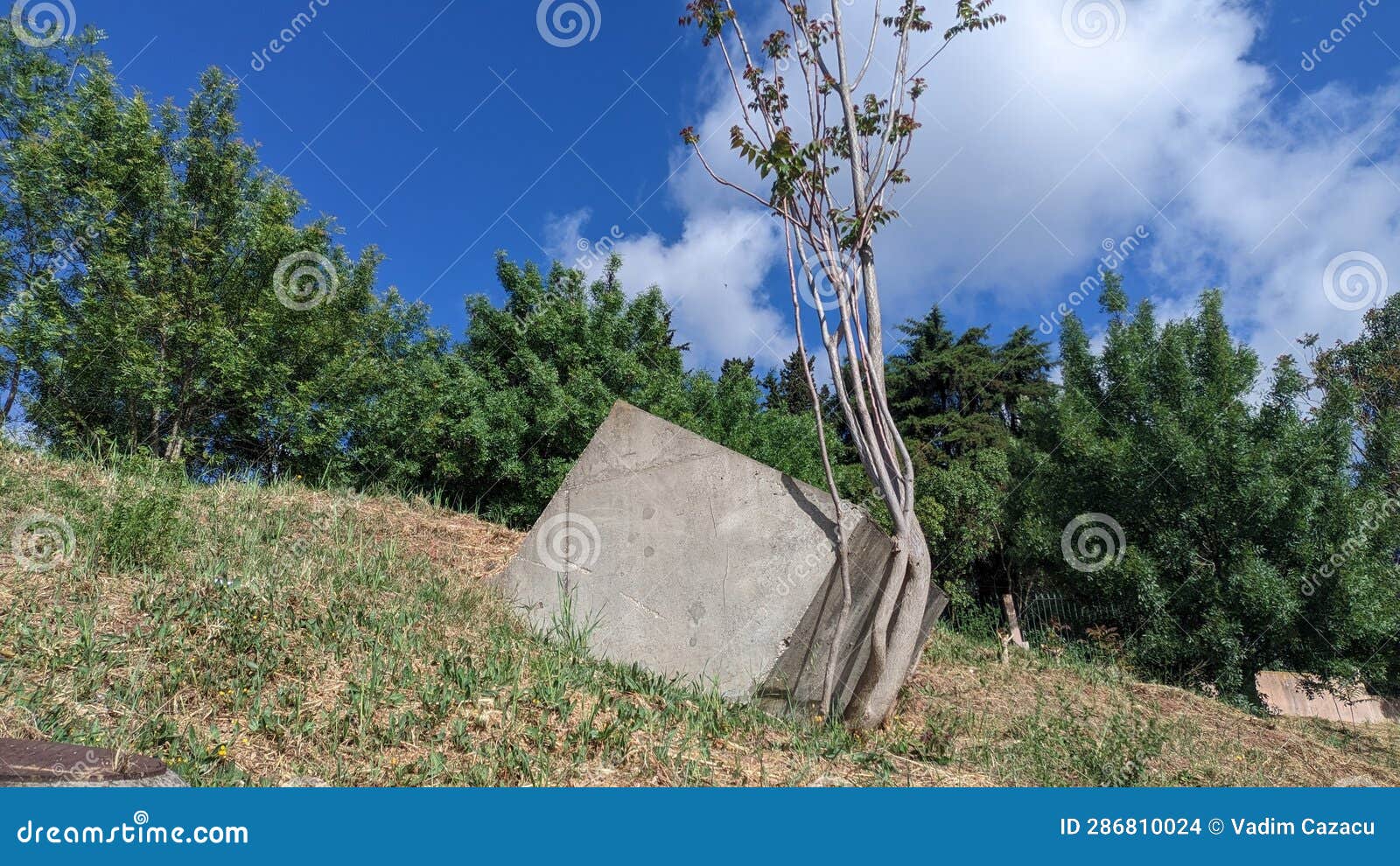 A Large Cube of Concrete Slid Down the Ground and Rested Against the ...
