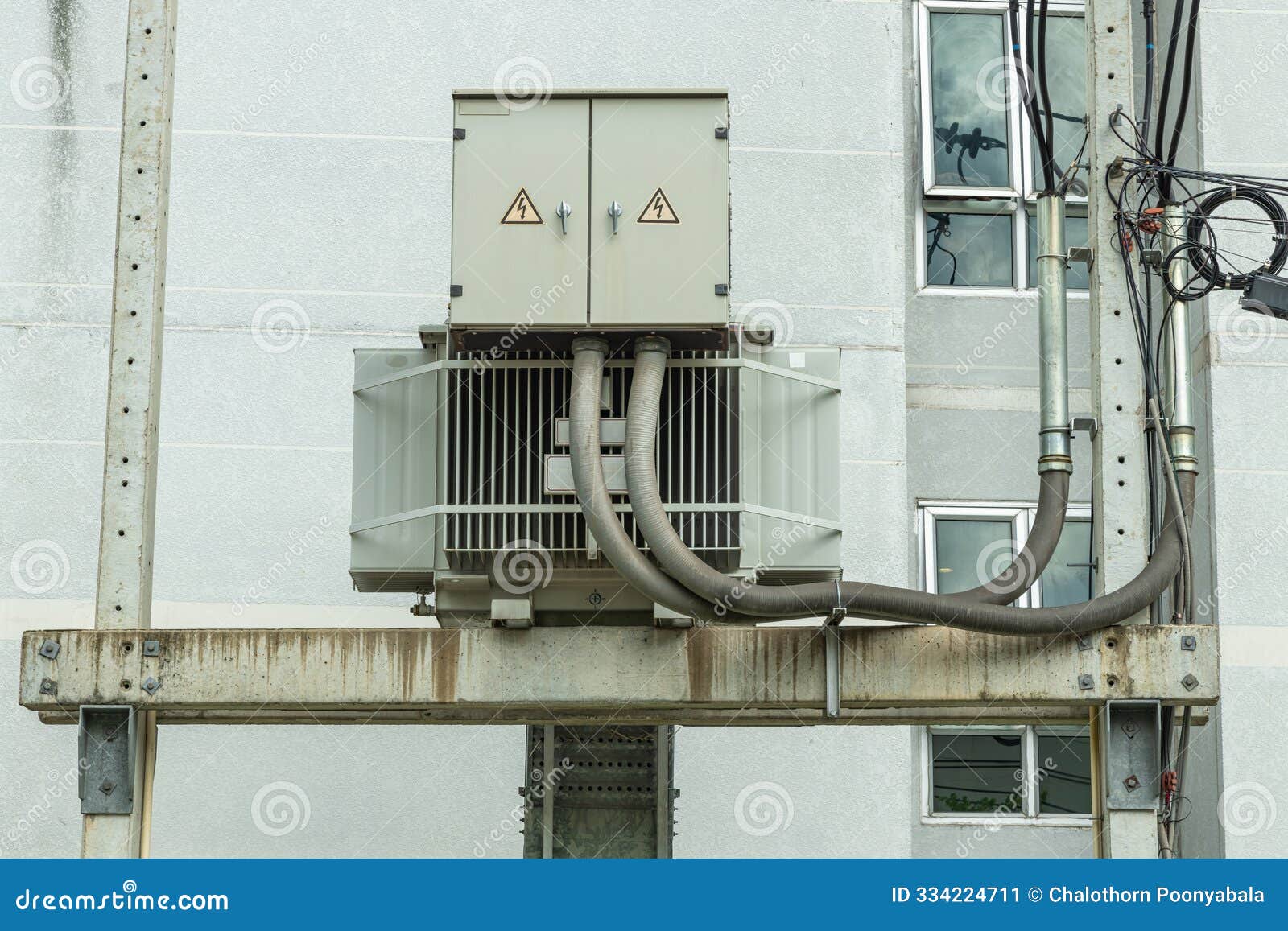 A Large Eletric Transformer is Mounted on Concrete Beams and Poles ...