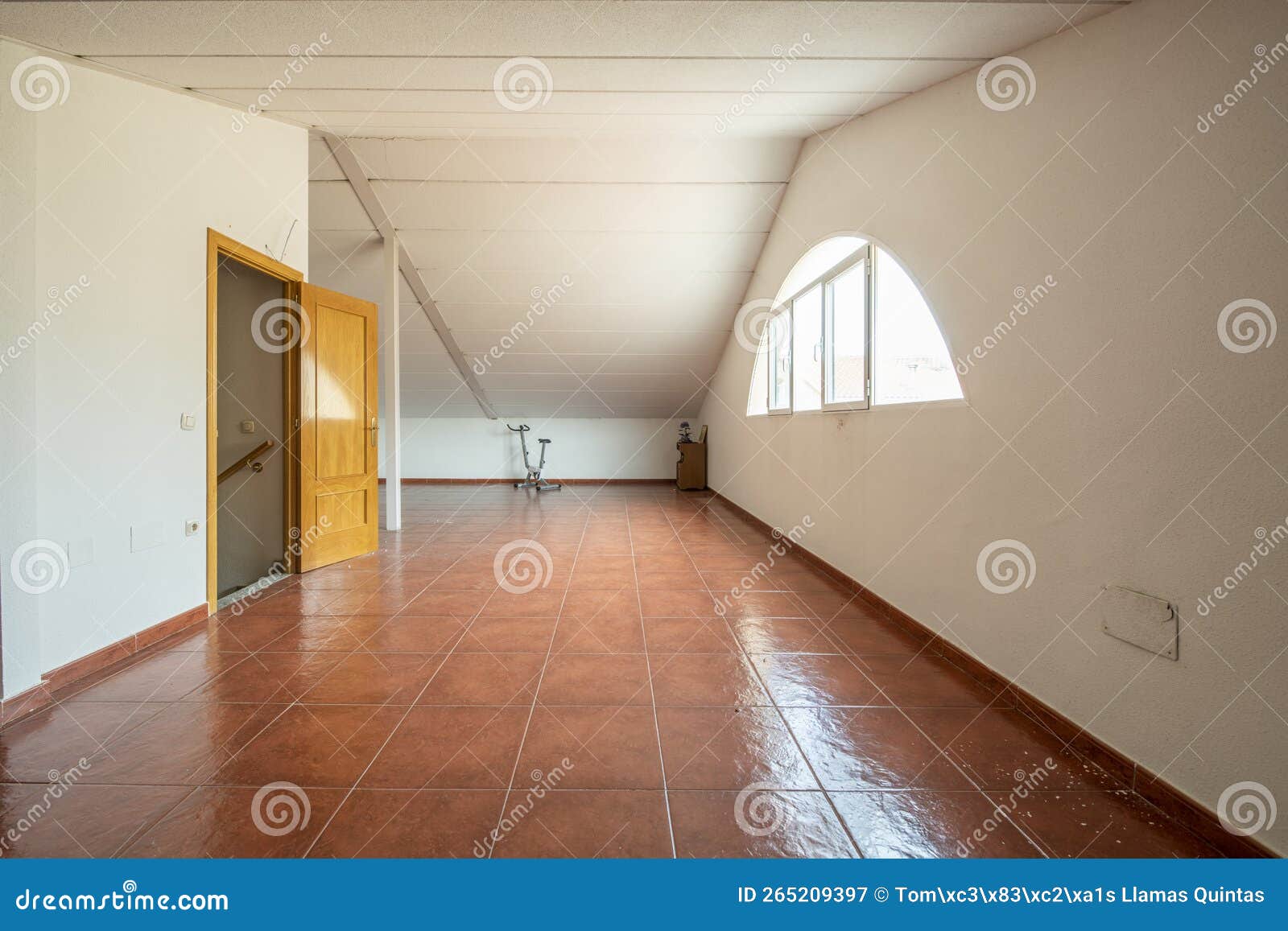 A Large Empty Hall of a Detached House in the Attic with Dormer Windows ...