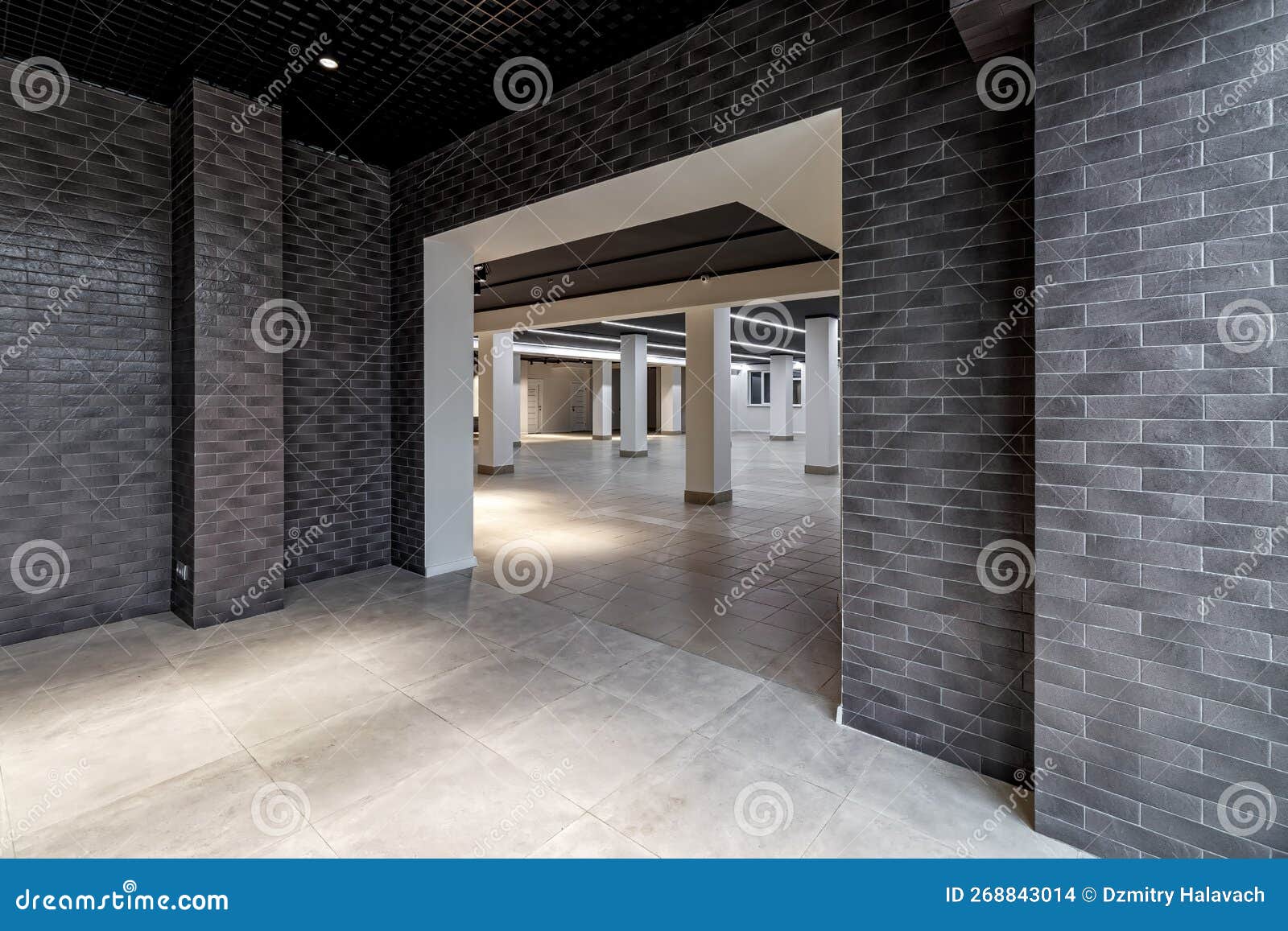 A Large Empty Room with Ceramic Tiles on the Floor, a Black Ceiling ...