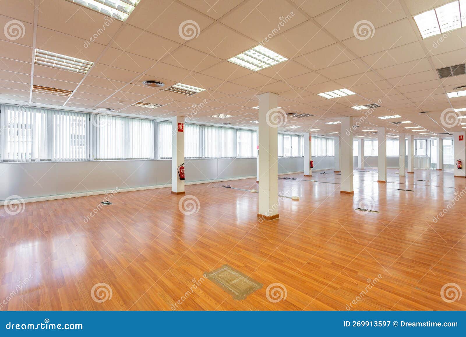 Large Empty Space with Ceiling Tiles, Fluorescent Lights, Light Brown ...