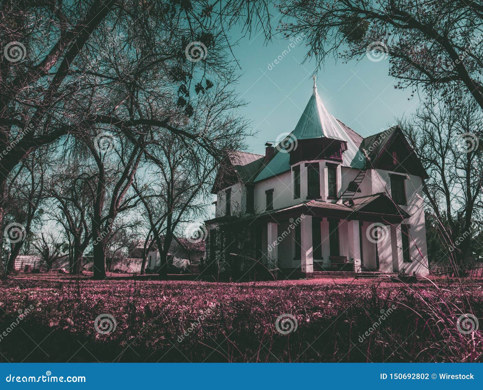 Large Estate with an Old White Building and Trees with a Clear Sky in ...