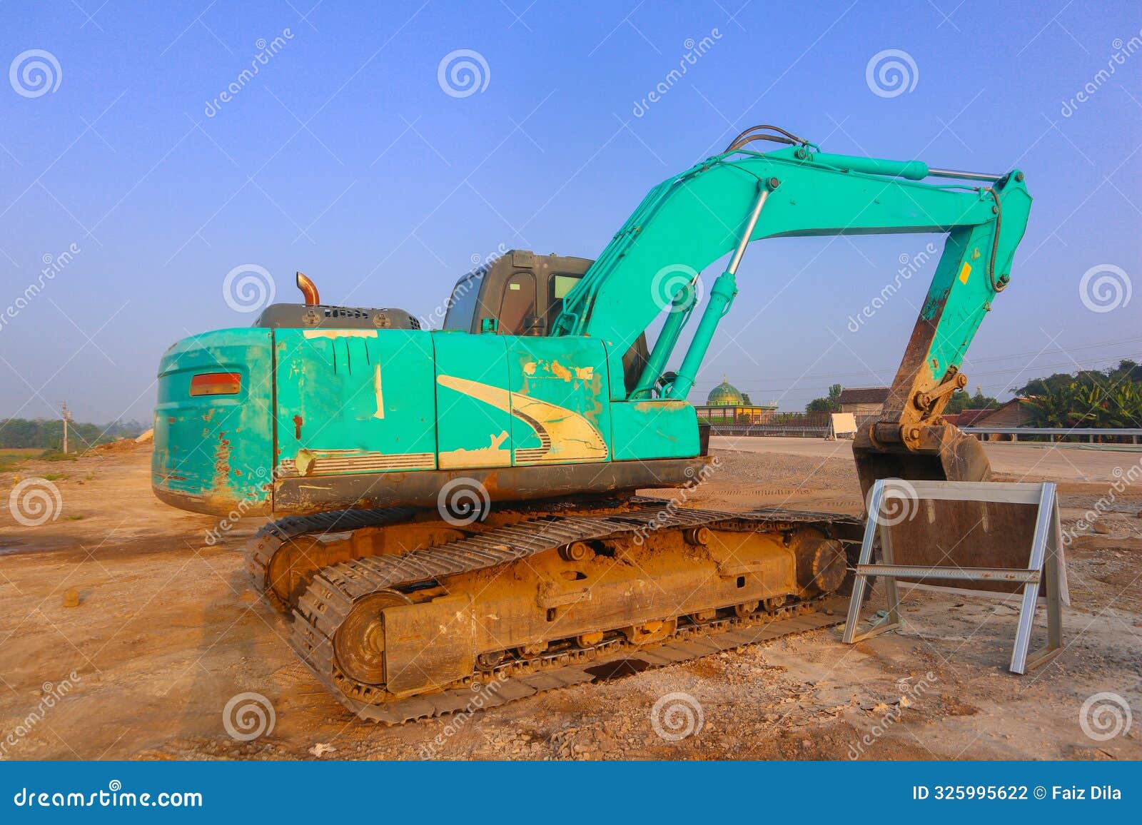 A Large Excavator or Backhoe Green and Blue Construction Machine is ...