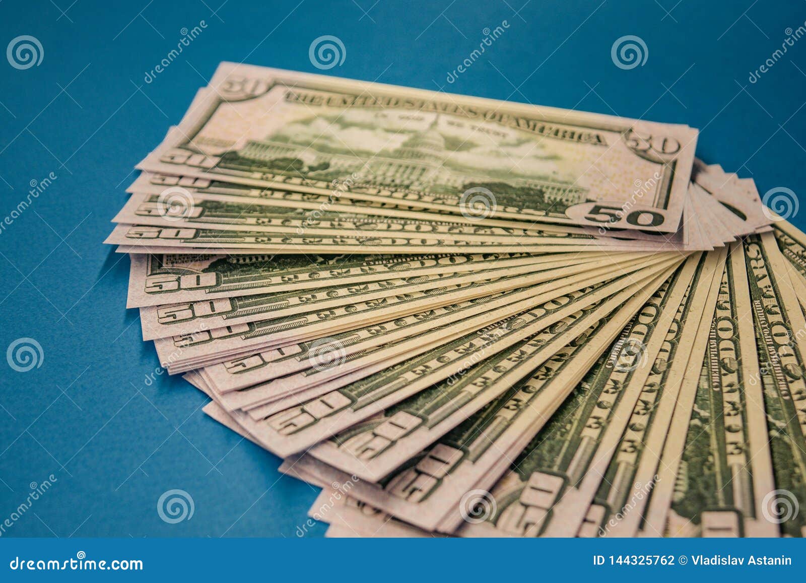 Large Fat Money Roll Isolated on a Blue Background Stock Photo - Image ...