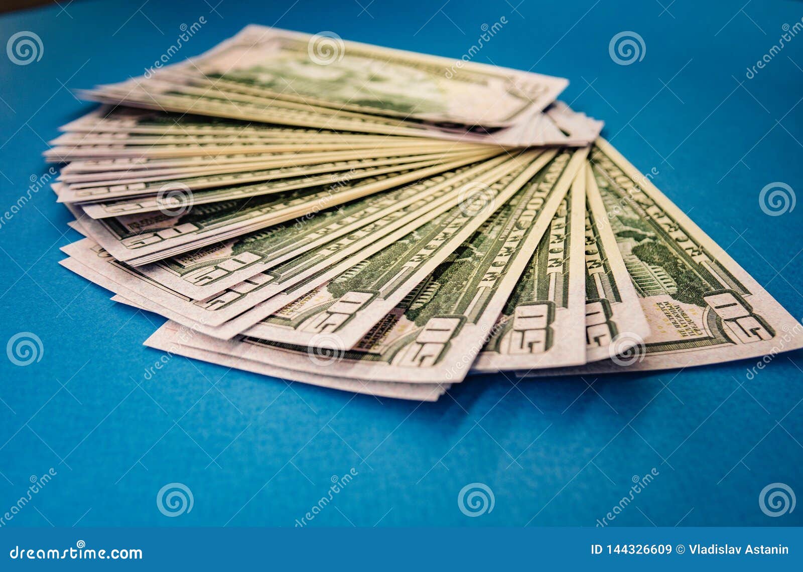 Large Fat Money Roll Isolated on a Blue Background Stock Image - Image ...