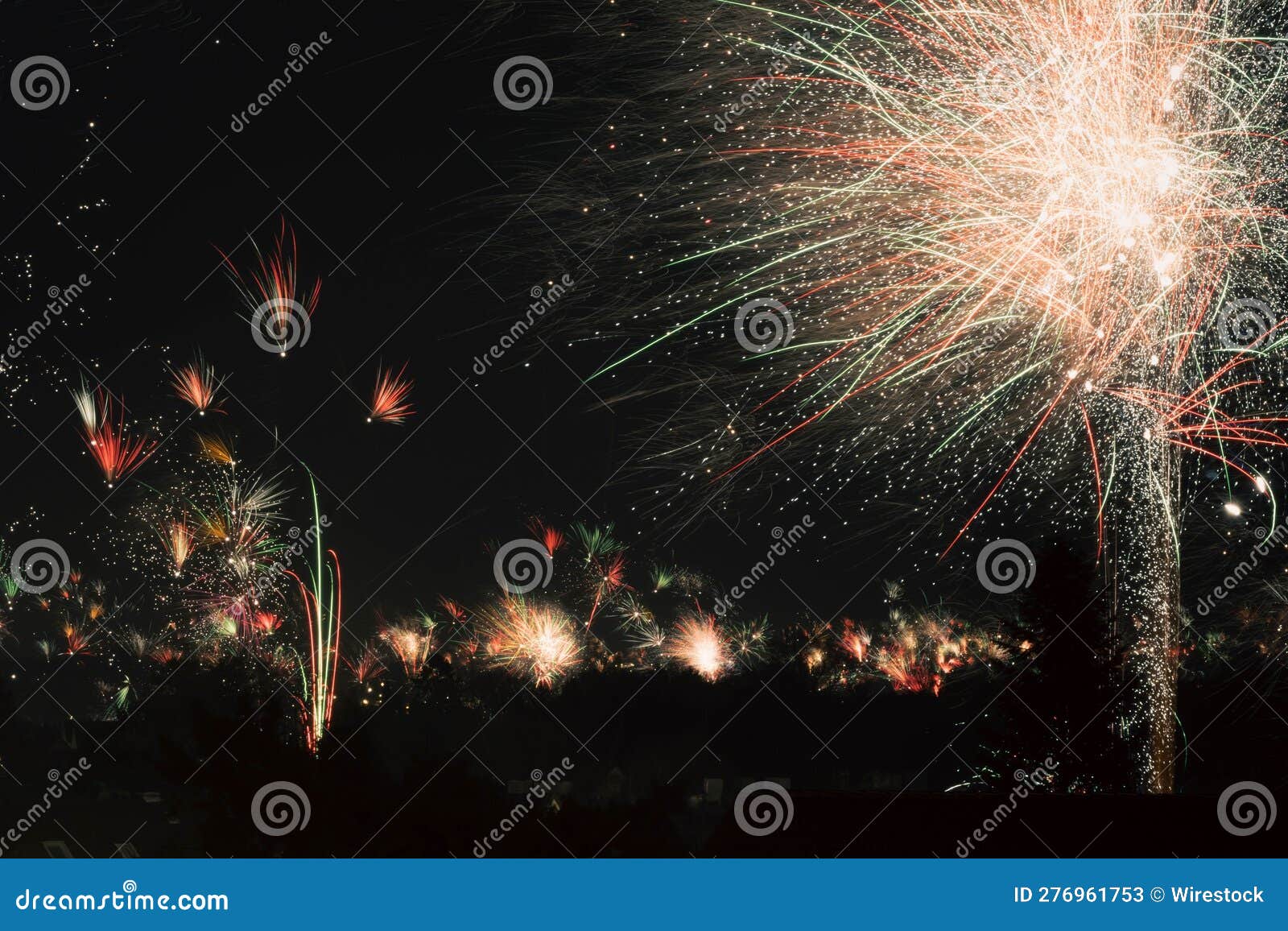 Large Firework Exploding in the Night Sky Over Trees in a Wooded Area ...