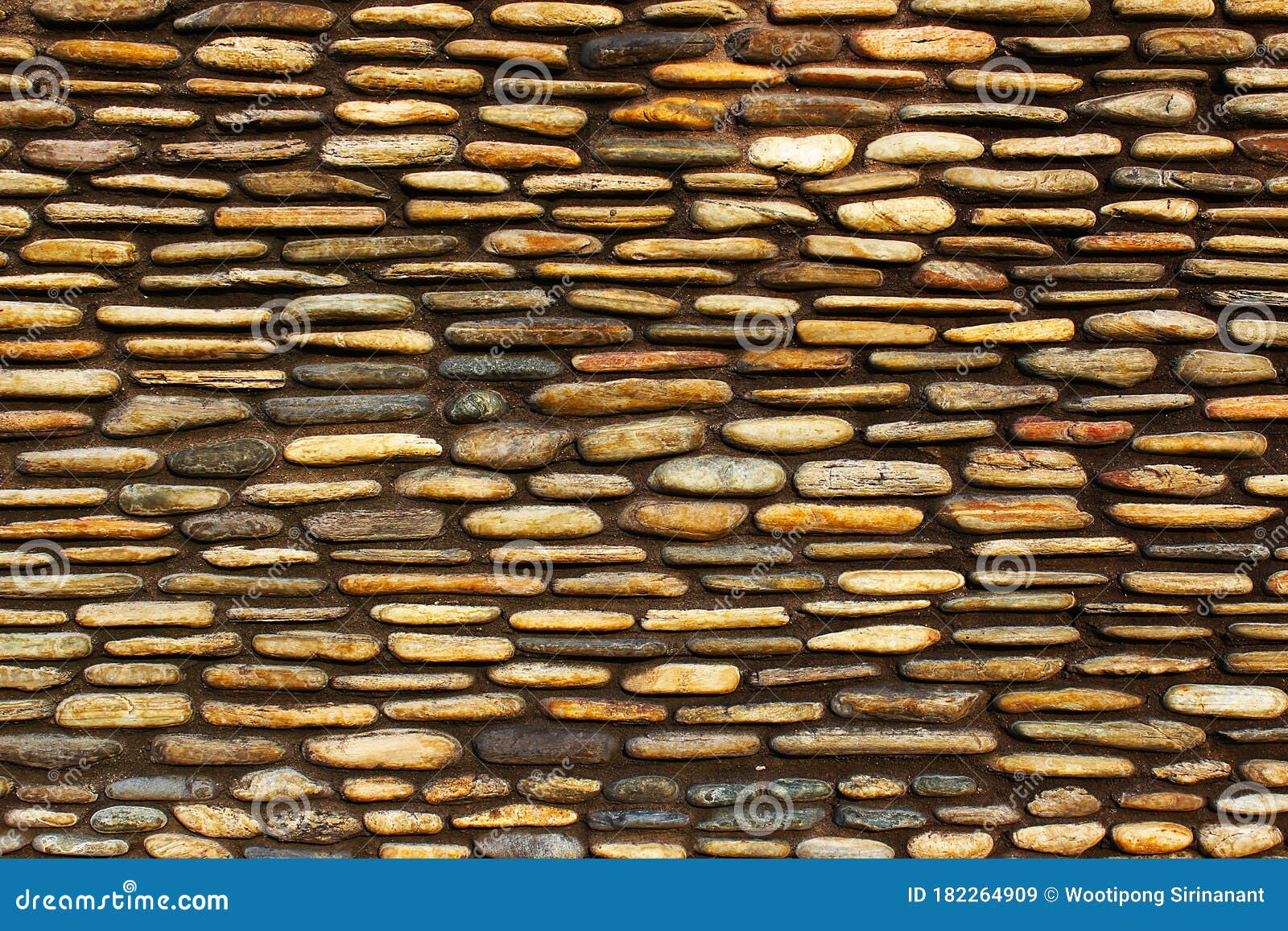 Large Flat Pebbles Arranged in Layers on the Wall Stock Image - Image ...