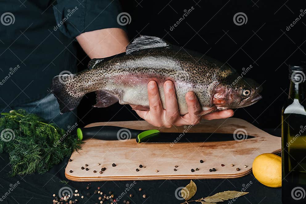 Large Fresh Fish in the Kitchen in the Hands of the Chef Stock Image ...