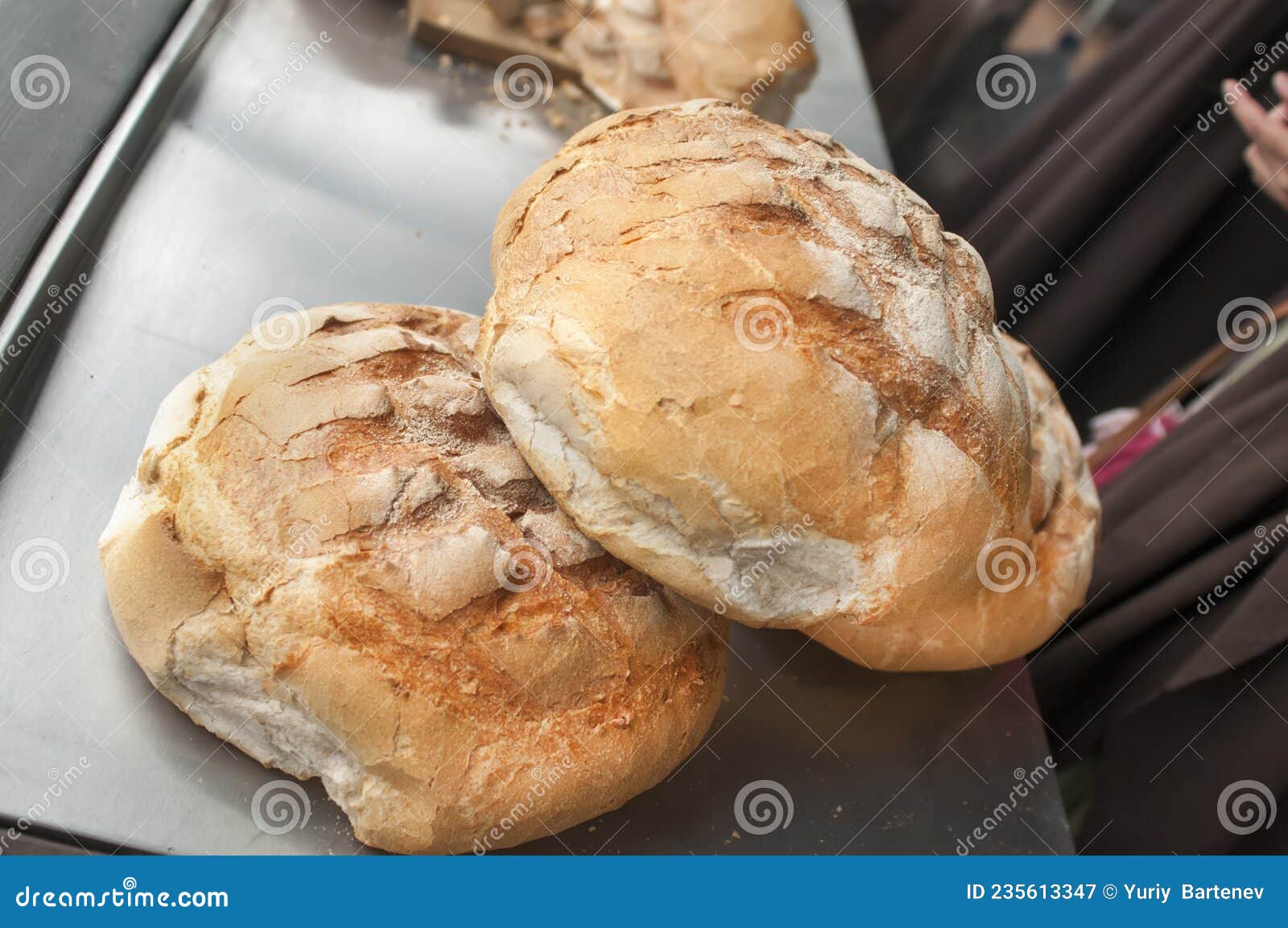 Large Fresh Loaves of Bread Lying on the Table. Stock Image - Image of ...