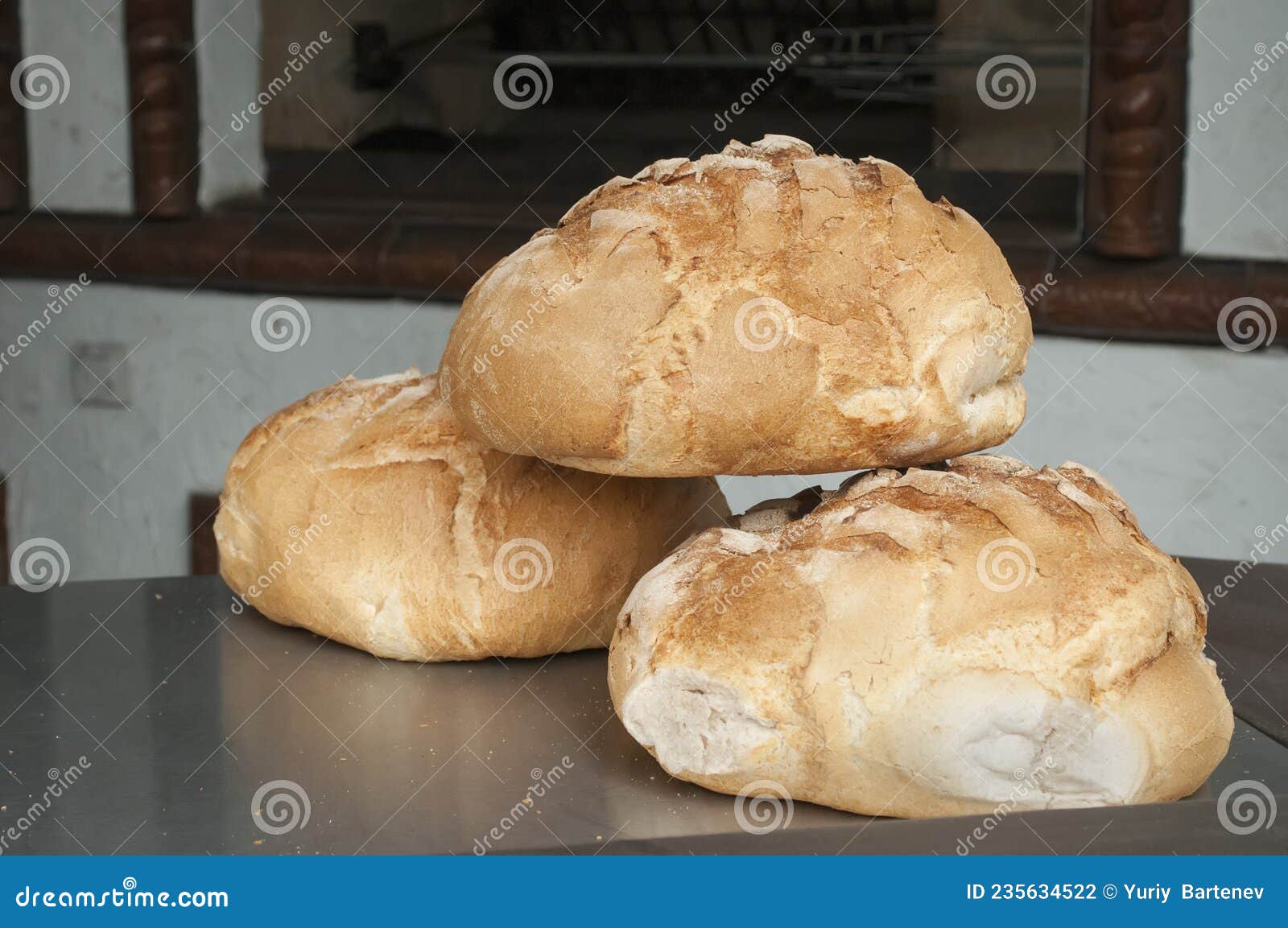 Large Fresh Loaves of Bread Lying on the Table. Stock Photo - Image of ...