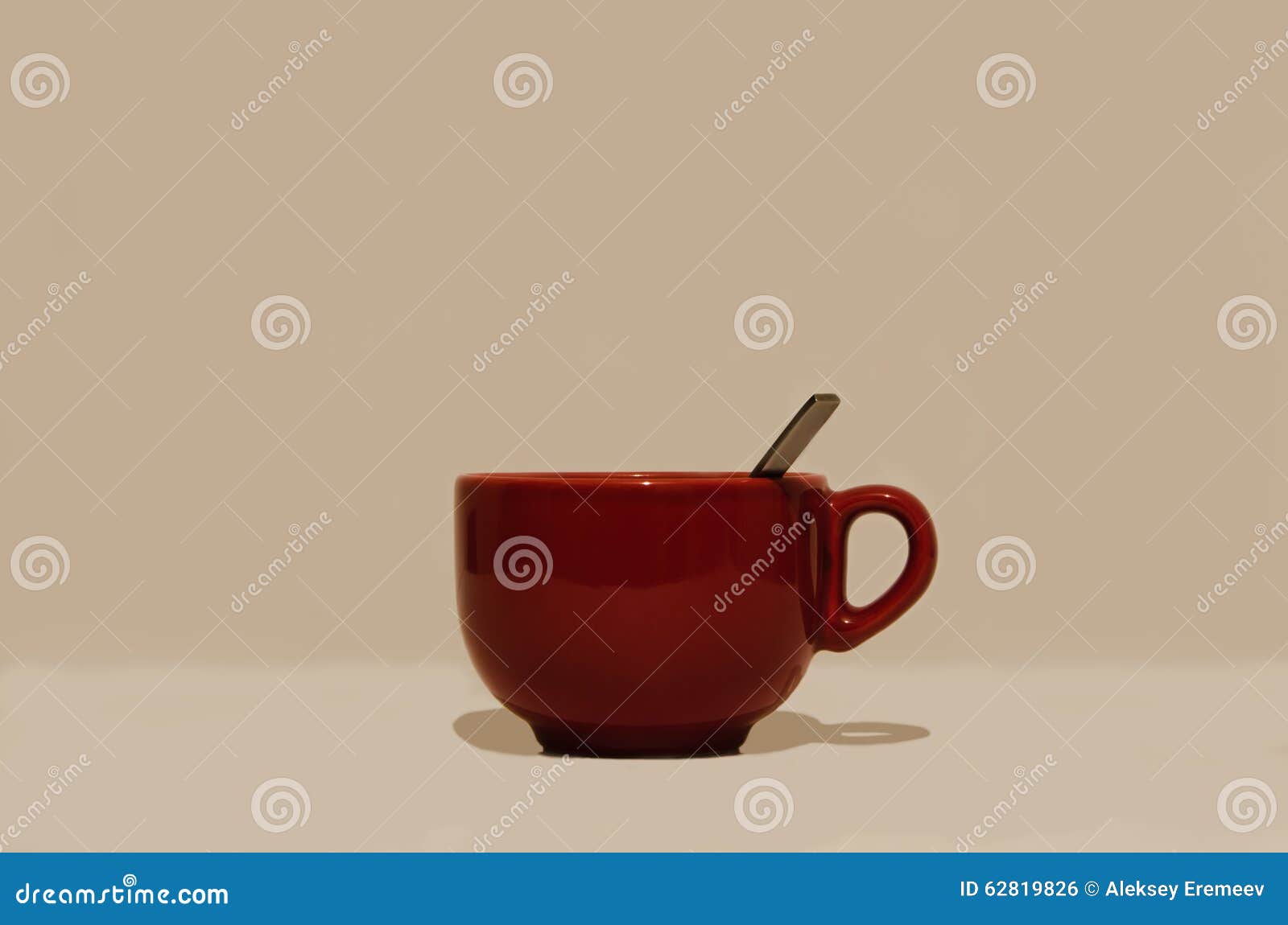 Large Glossy Red Round Cup with a Handle and a Spoon Stock Photo ...
