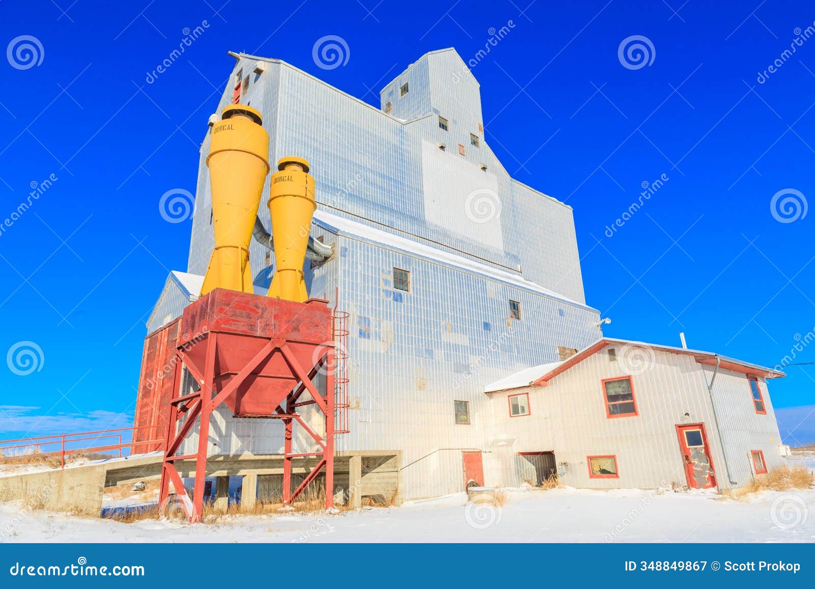 A Large Grain Silo with Two Orange Silos on Top Stock Image - Image of ...