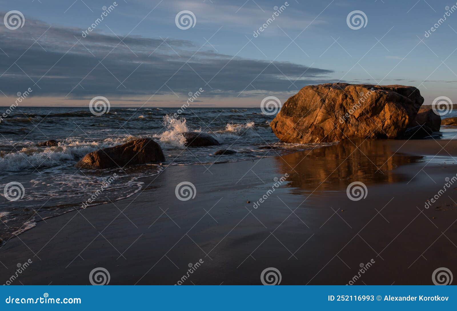 A Large Granite Stone on a Sandy Sea Beach at the Beginning of Sunset ...
