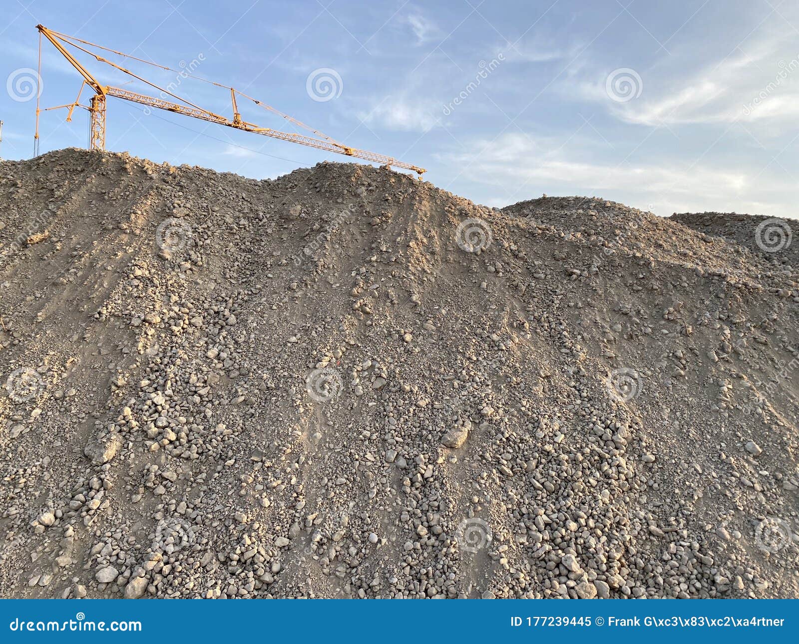 Large Gravel Mound with Construction Crane in the Background Stock ...