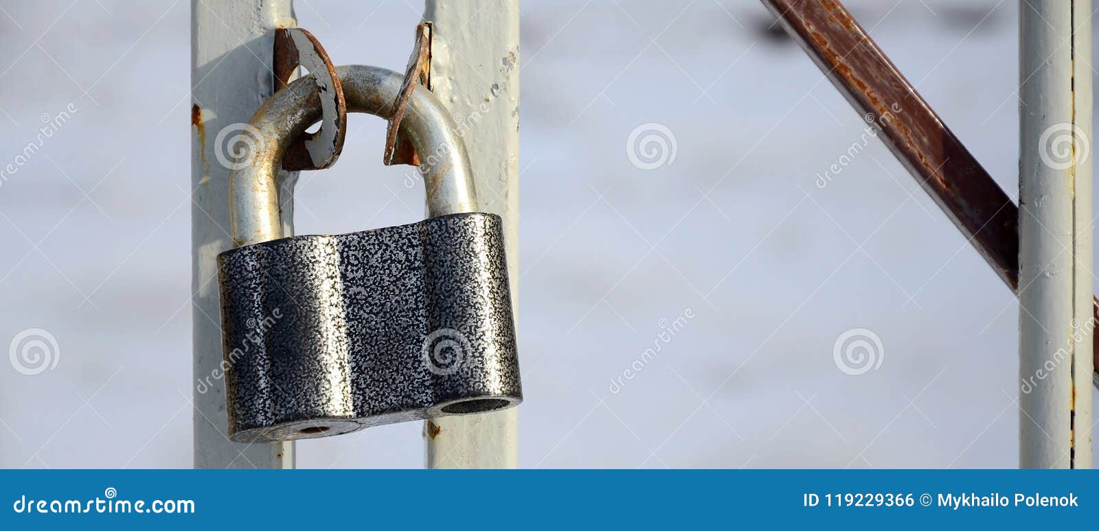 A Large Gray Padlock Hangs on a Metal Gate Stock Photo - Image of ...