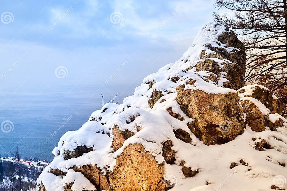 A Large Grey Rock Face on the Edge of a Cliff at a Height of and a ...