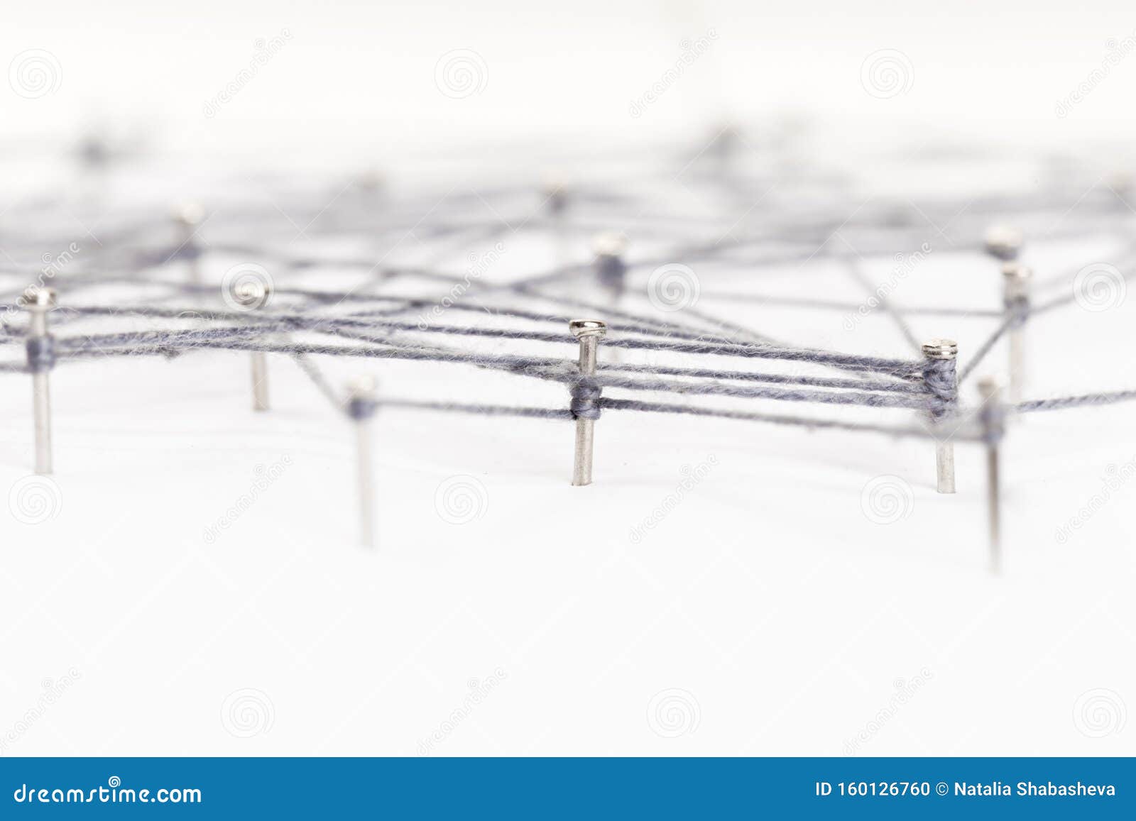 A Large Grid of Pins Connected with String. Communication, NetwA Large ...