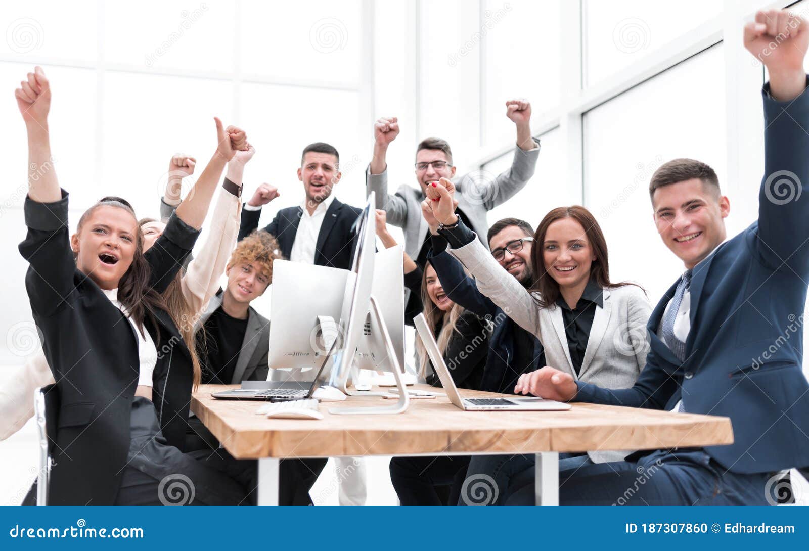 Large Group of Diverse Employees Celebrate while Sitting at a Table ...