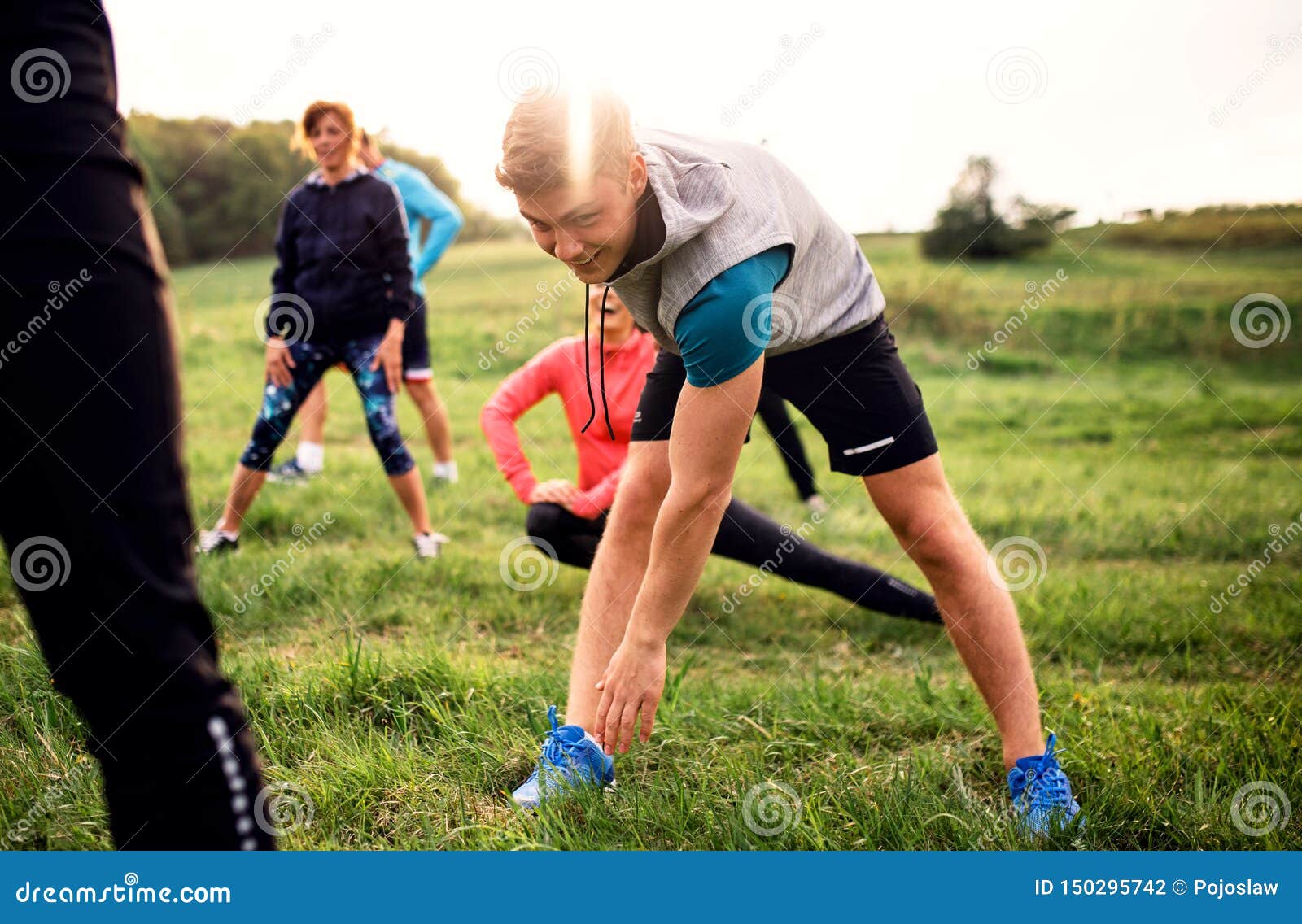 Large Group of Fit and Active People Doing Exercise in Nature. Stock ...